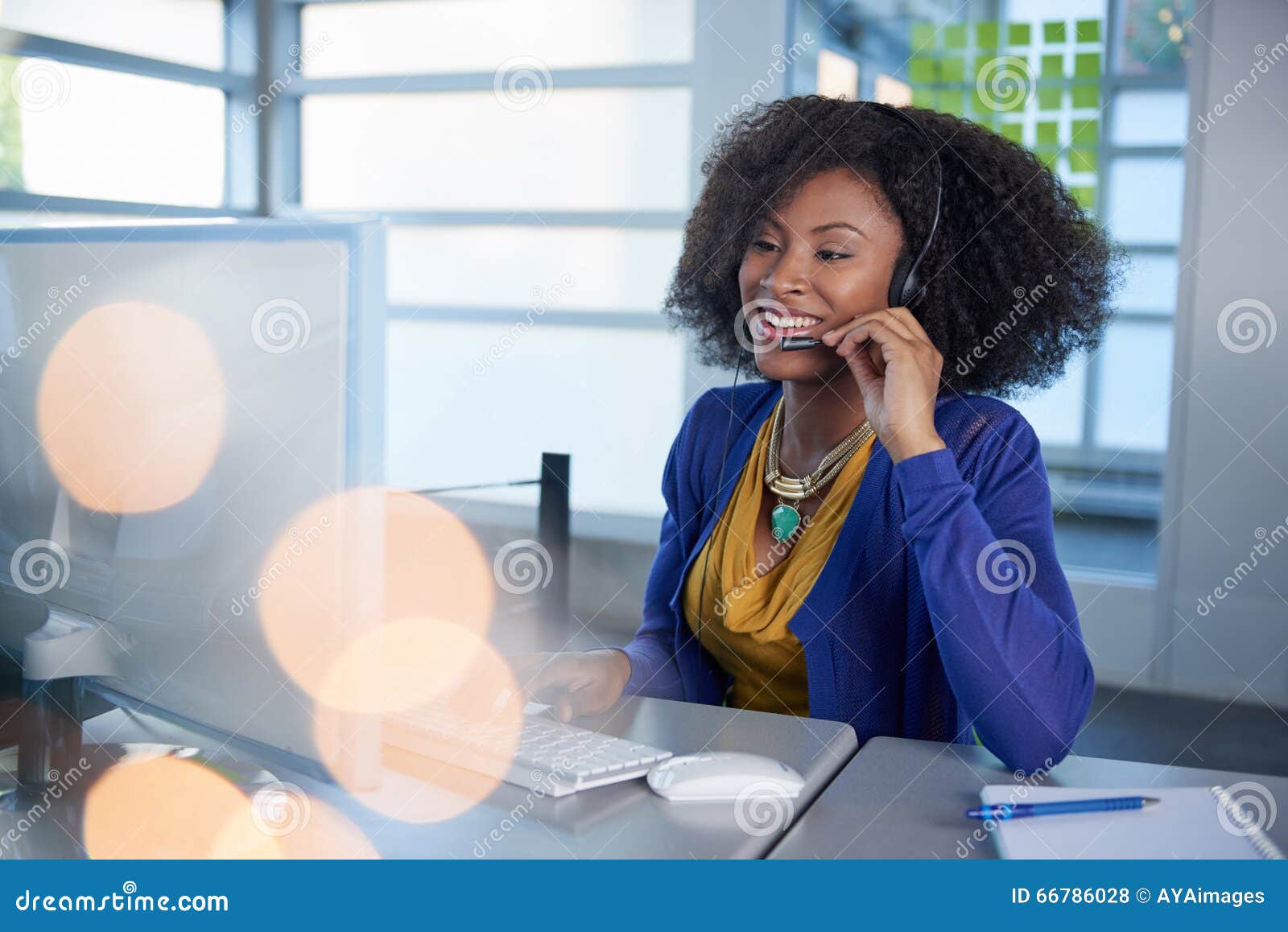 Portrait of a Smiling Customer Service Representative with an Afro at ...