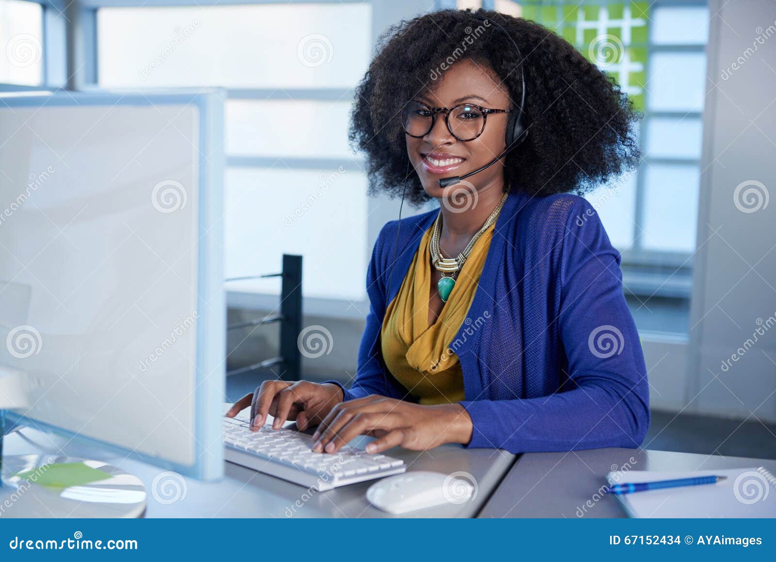 Portrait of a Smiling Customer Service Representative with an Afro at ...