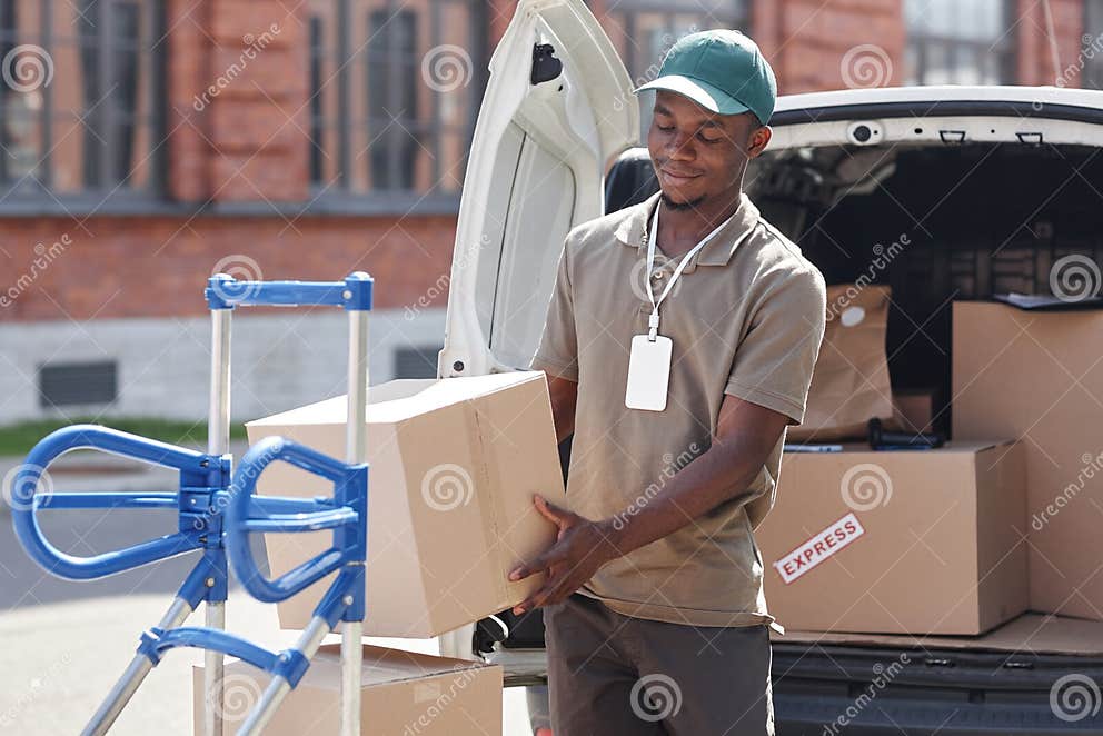 Male Delivery Worker Unloading Boxes Stock Photo - Image of work ...