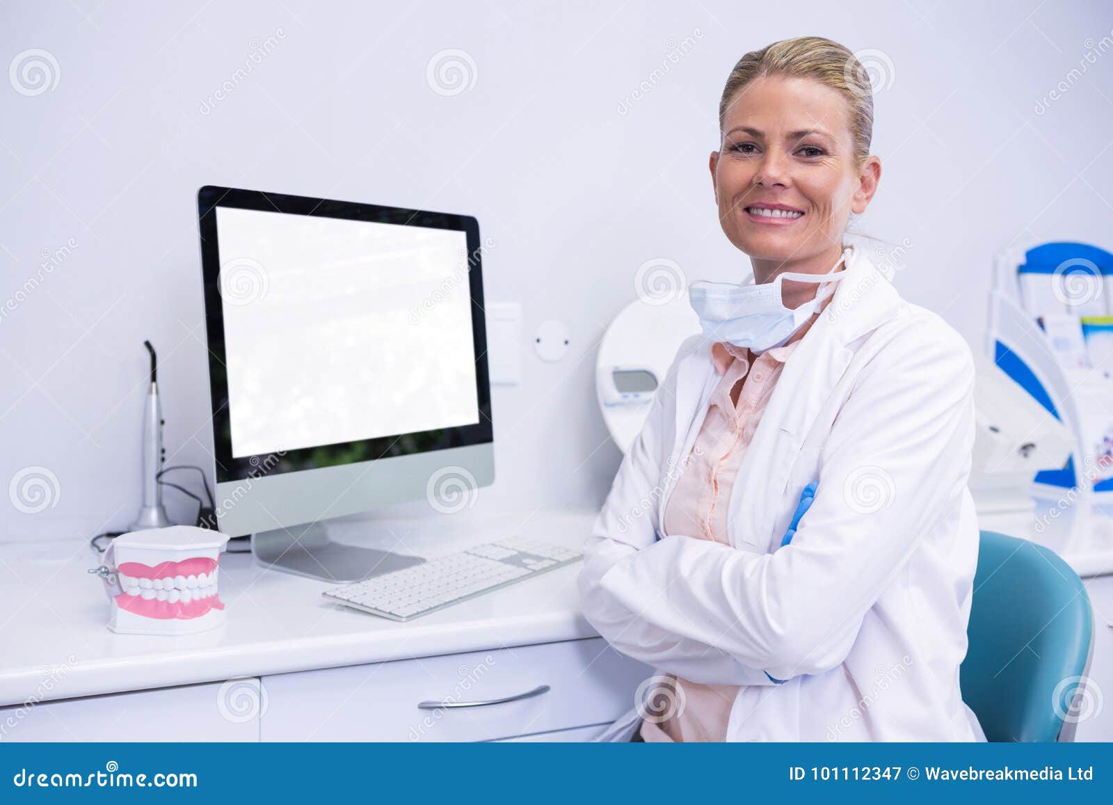 Portrait of Smiling Dentist Working while Sitting by Computer Stock ...