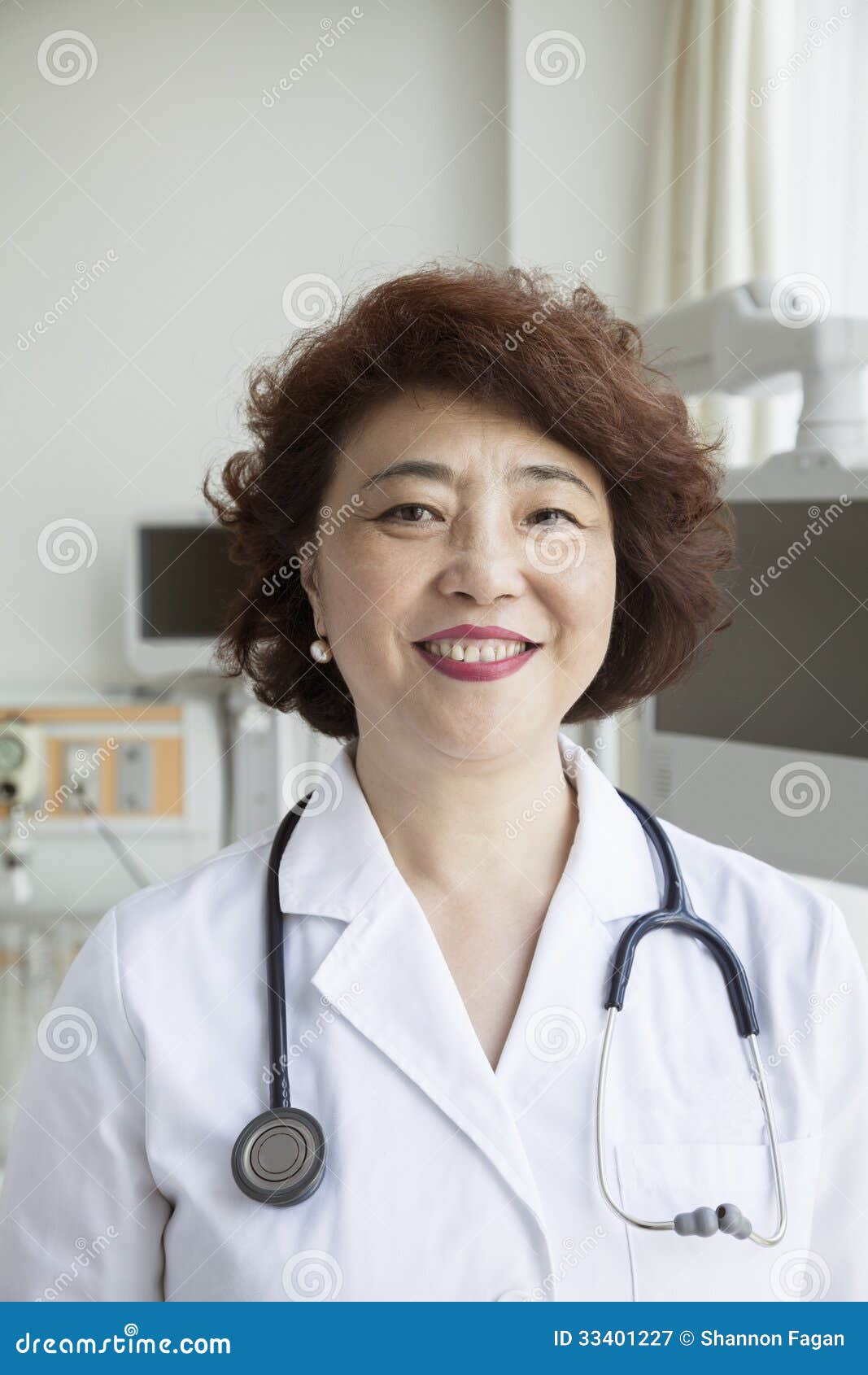 Portrait of Smiling Female Doctor with a Stethoscope Looking at Camera ...