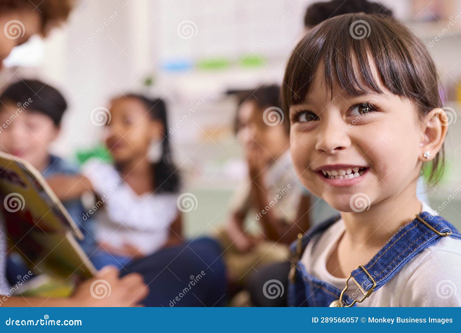 Portrait of Smiling Female Elementary School Pupil Sitting in Classroom ...