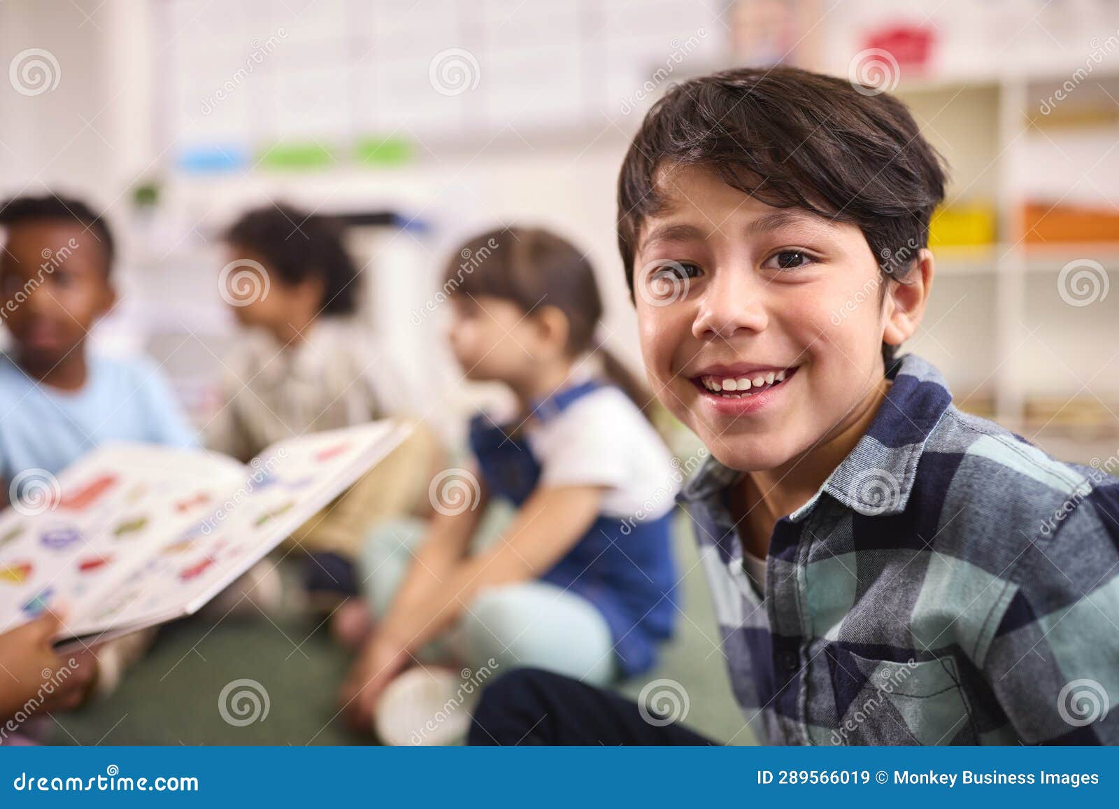 Portrait of Smiling Male Elementary School Pupil Sitting in Classroom ...