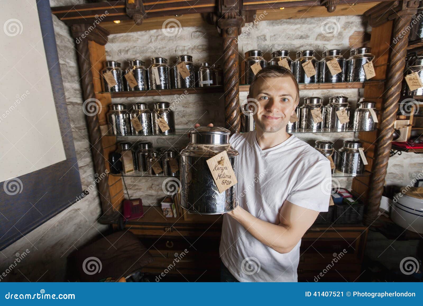 Portrait of Smiling Male Owner Displaying Tea Container in Store Stock ...