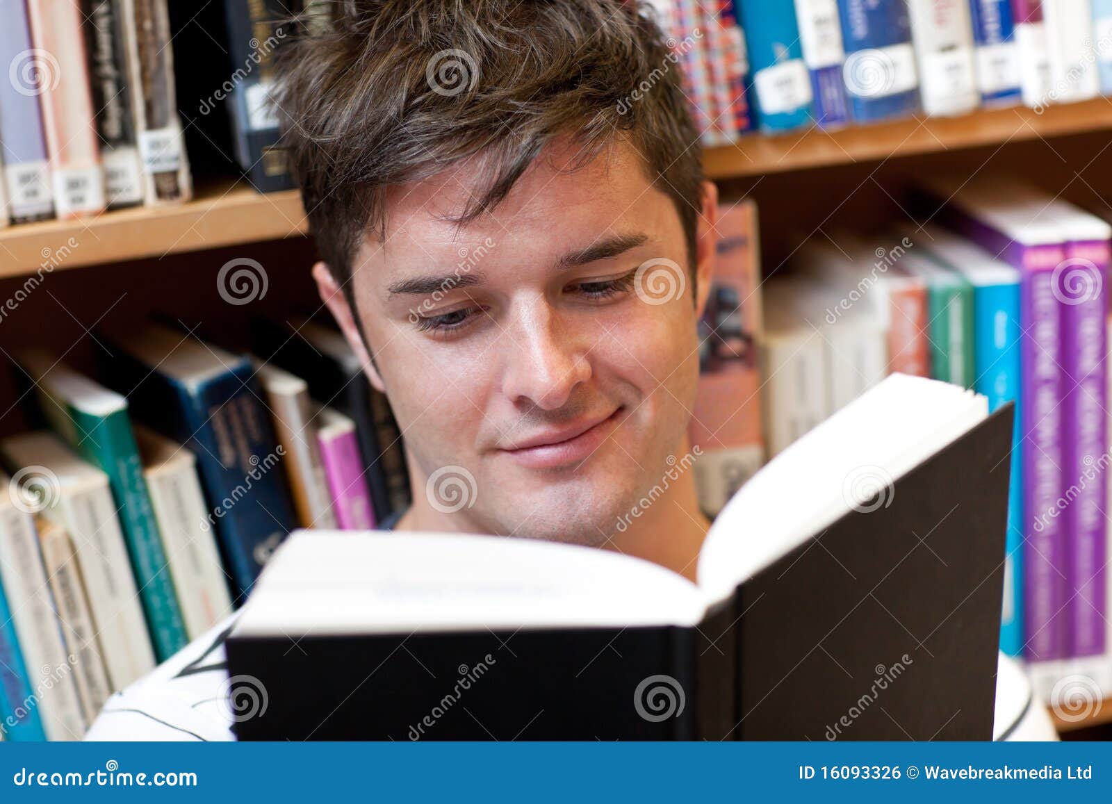 Portrait of a Smiling Male Student Reading a Book Stock Photo - Image ...