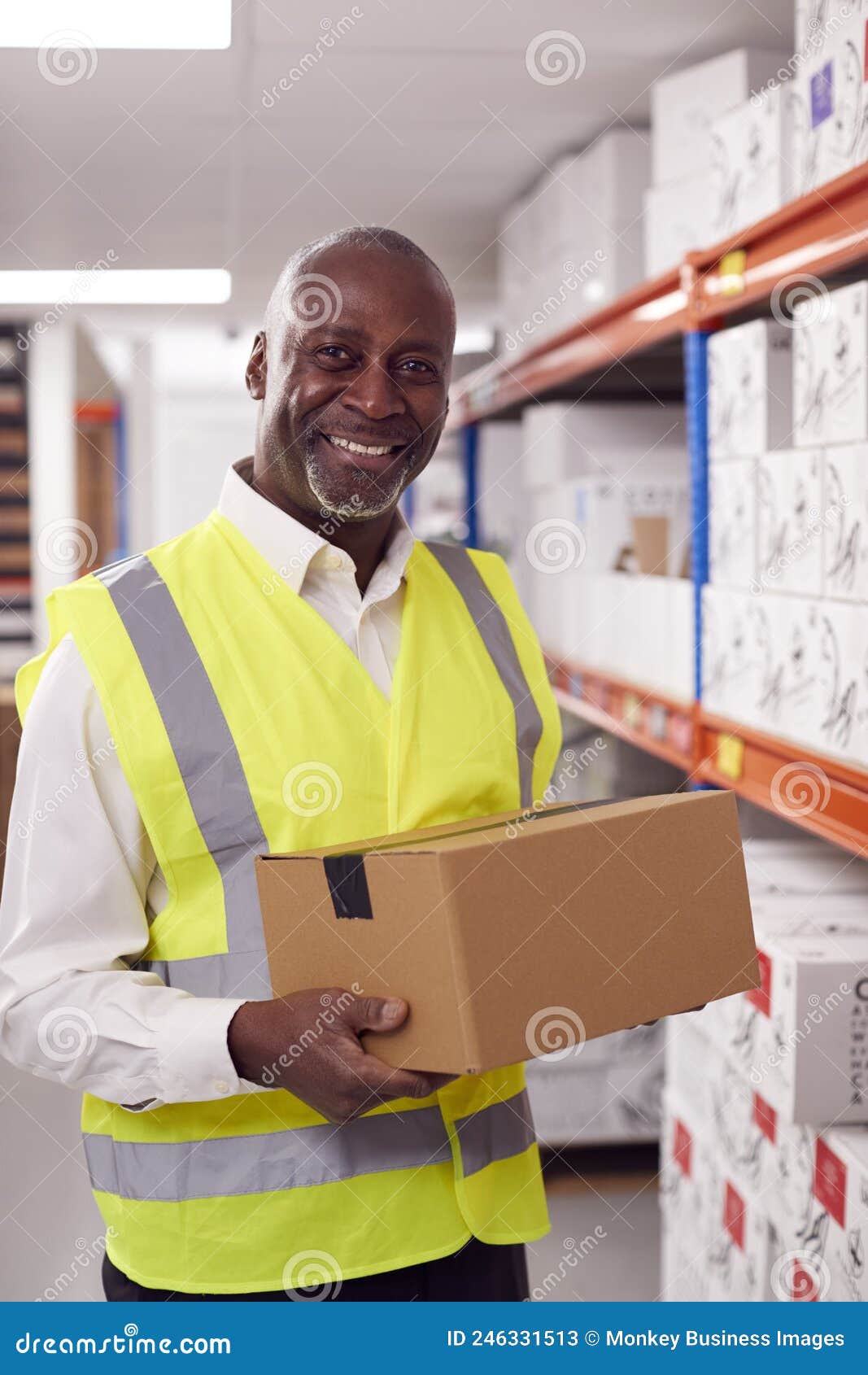 Portrait of Smiling Male Worker Holding Box Inside Warehouse Stock ...