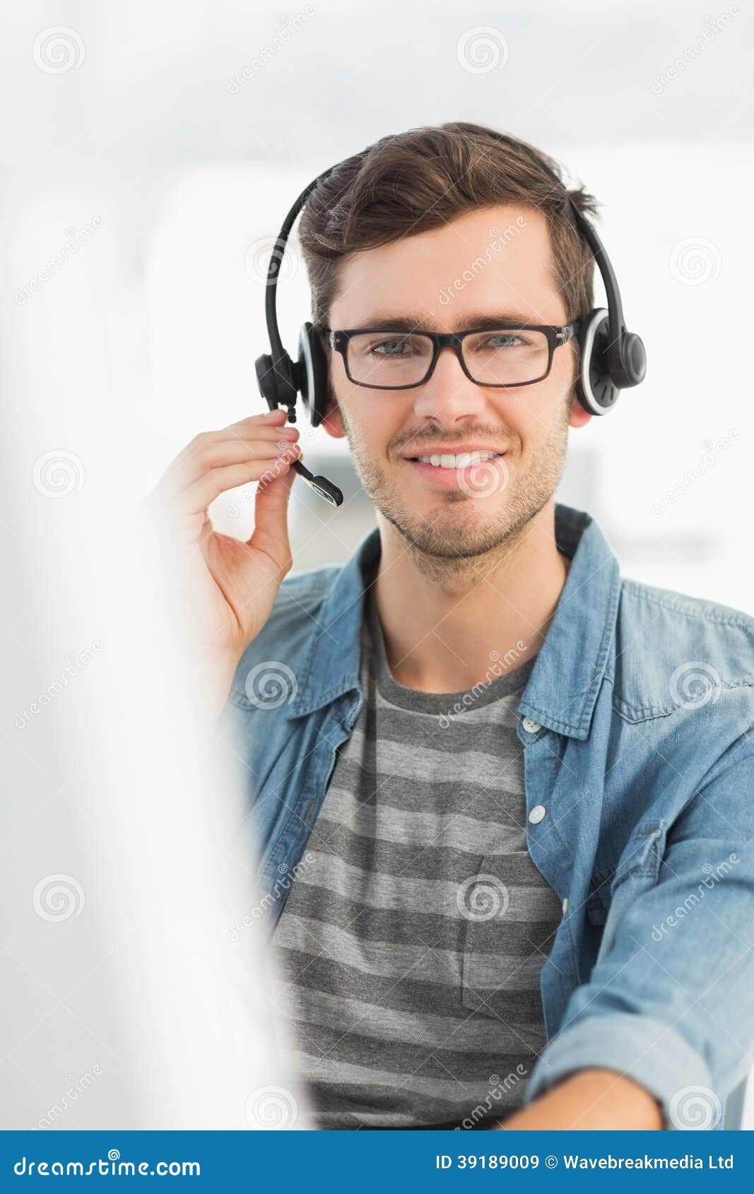 Portrait of a Smiling Man with Headset Using Computer Stock Image ...