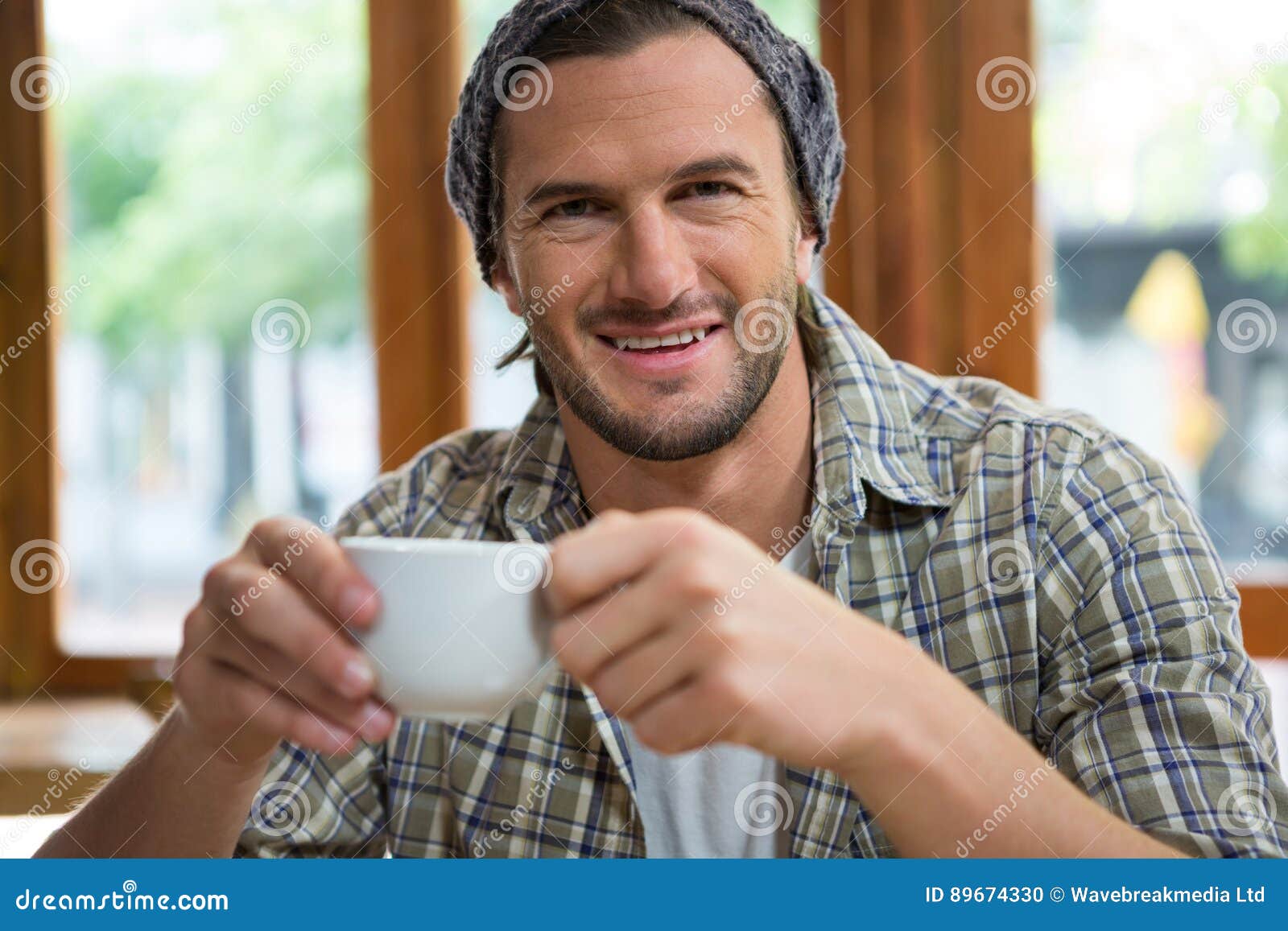 Portrait of Smiling Man Holding Coffee Cup in Cafeteria Stock Photo ...