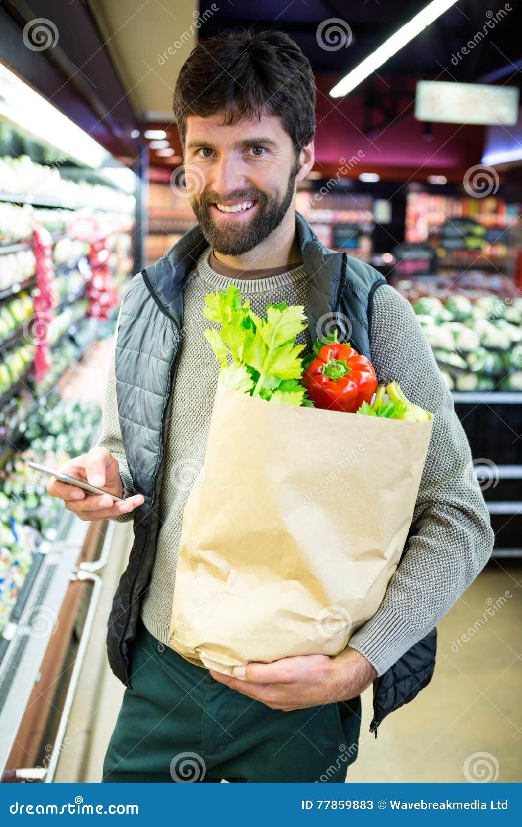 Portrait of Smiling Man Holding a Grocery Bag in Organic Section Stock ... Portrait of Smiling Man Holding a Grocery Bag in Organic Section Stock ...