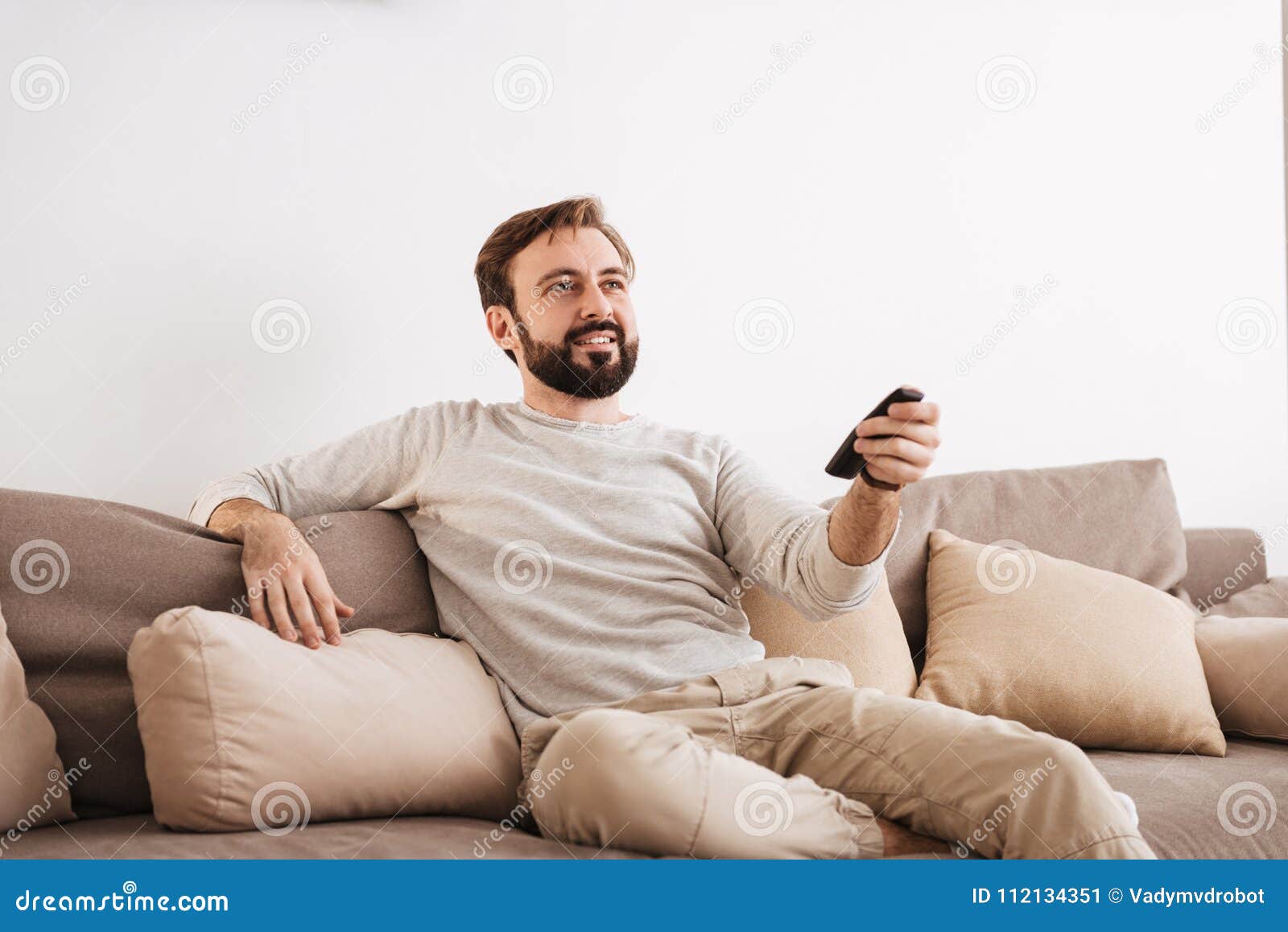 Portrait of a Smiling Man Holding Remote Control Stock Image - Image of ...