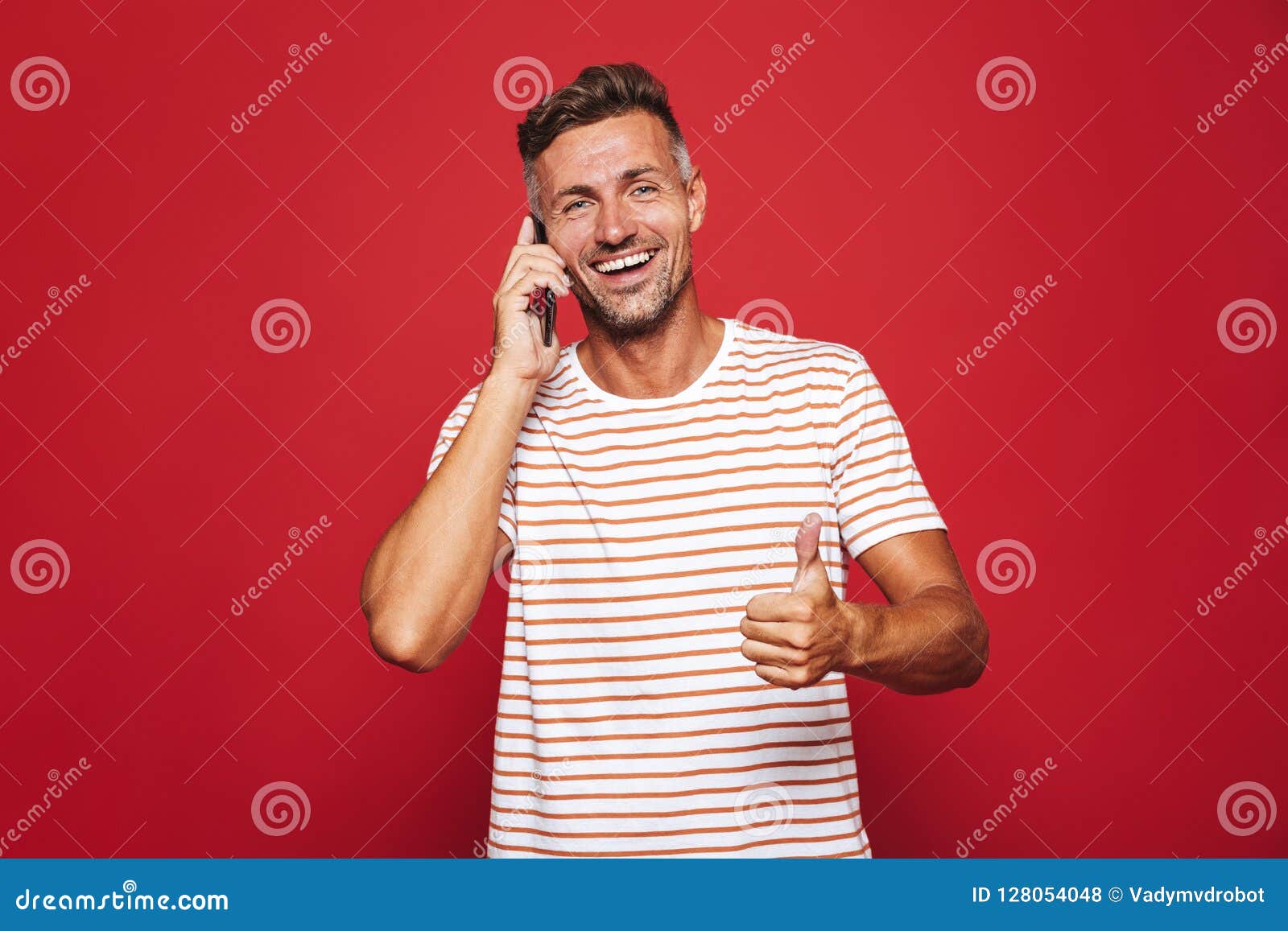Portrait of a Smiling Man Standing Over Red Background Stock Photo ...