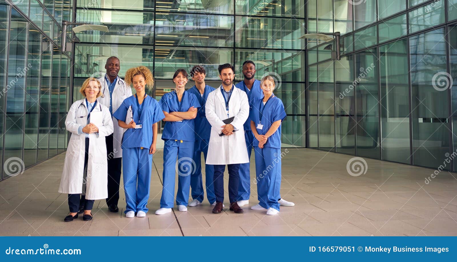 Portrait of Smiling Medical Team Standing in Modern Hospital Building ... Portrait of Smiling Medical Team Standing in Modern Hospital Building ...