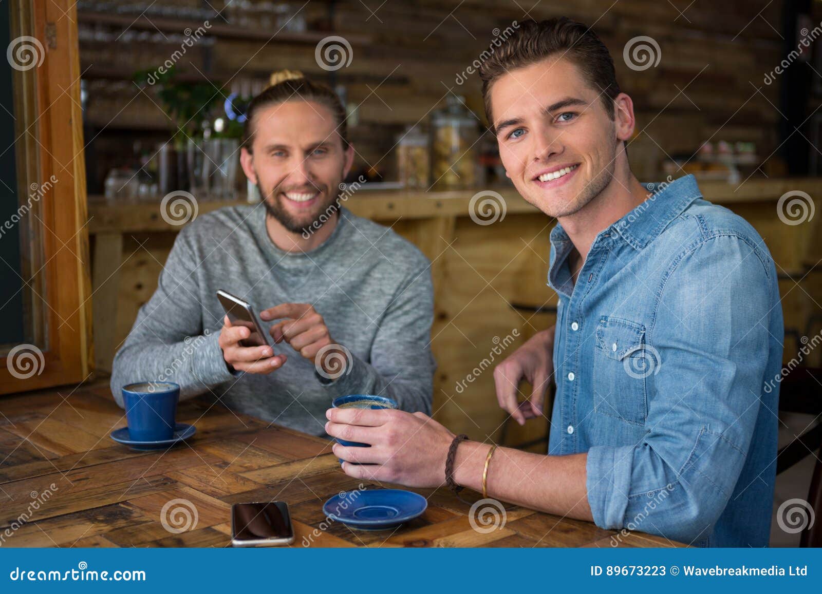 Portrait of Smiling Men Sitting at Table in Coffee Shop Stock Image ...