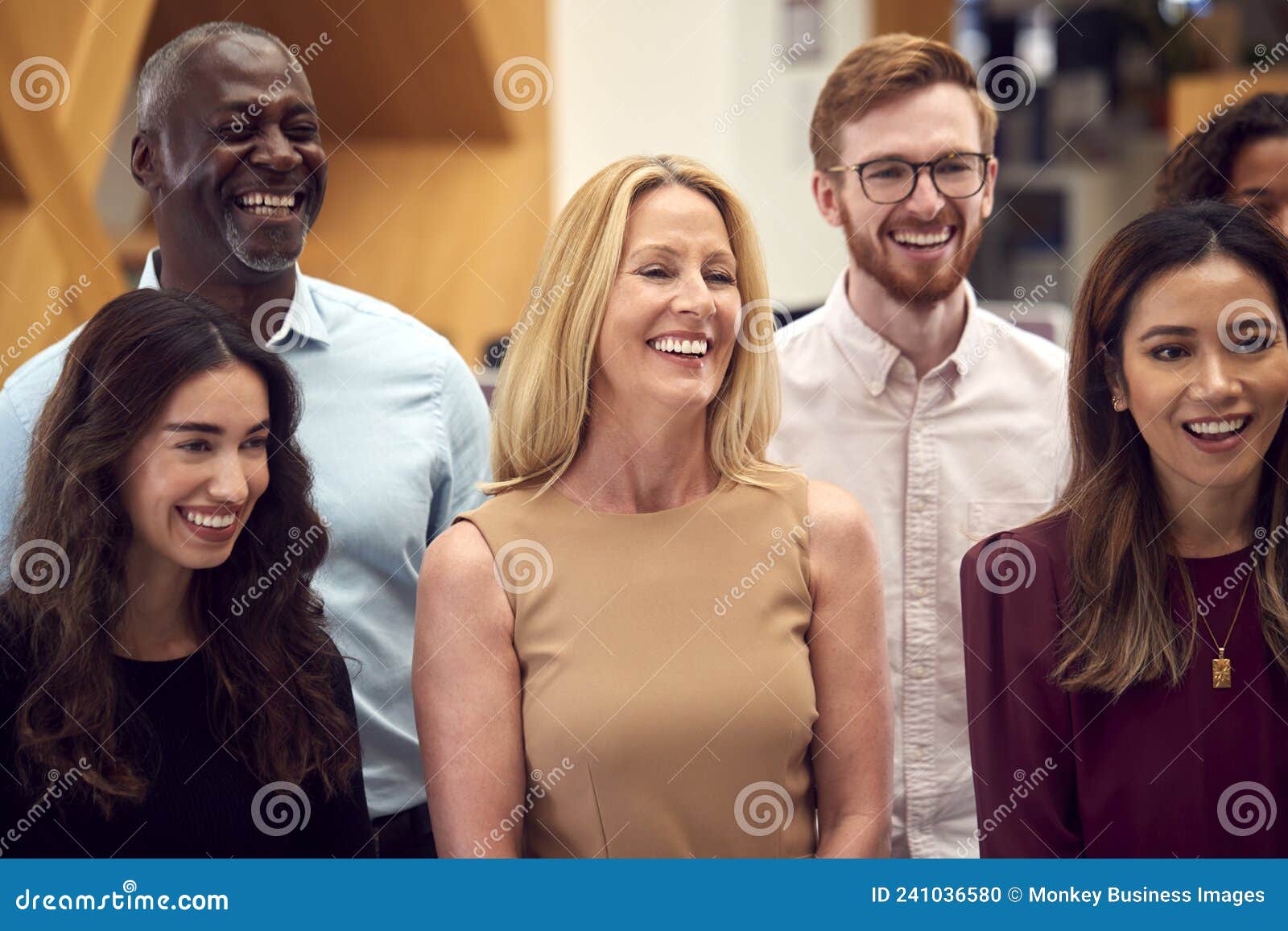 Portrait Of Smiling Multi Cultural Business Team Standing In Modern
