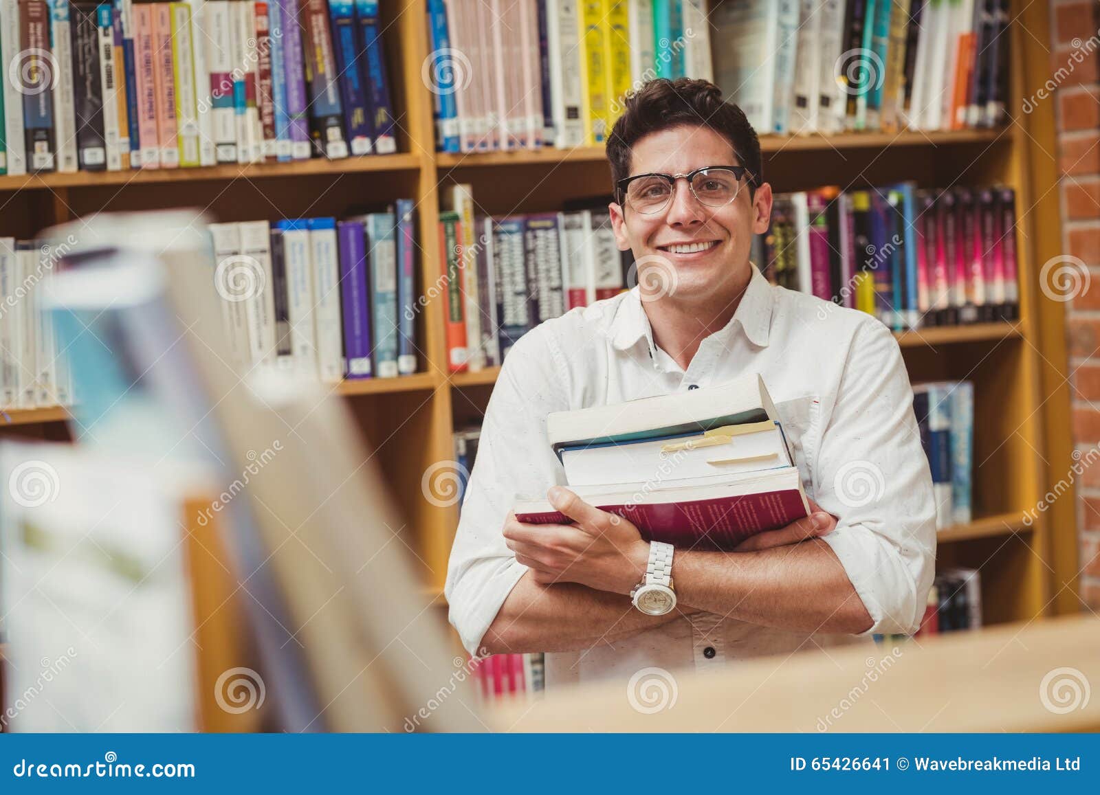 Portrait of Smiling Nerd Holding Books Stock Image - Image of interior ...