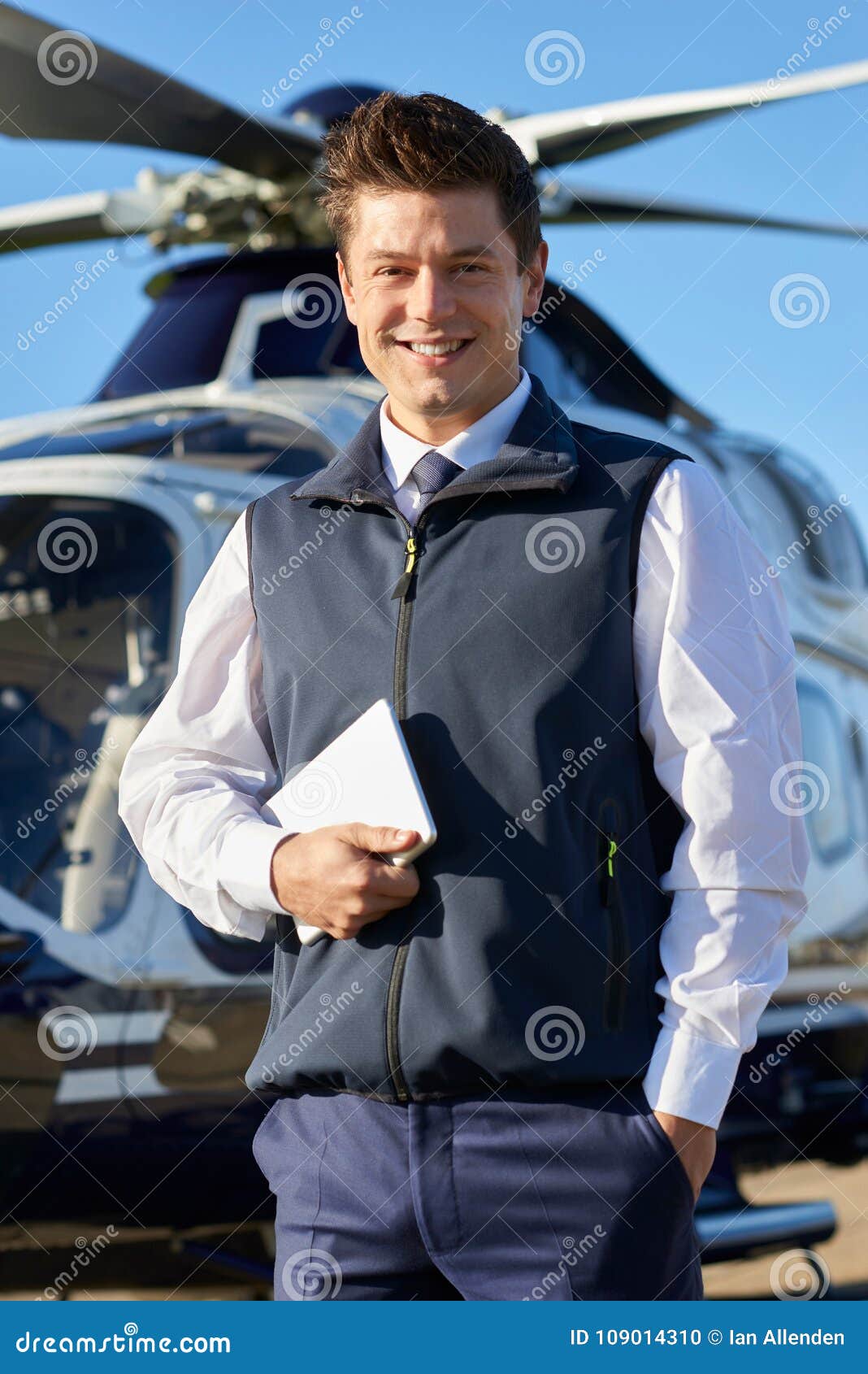 Portrait of Smiling Pilot Standing in Front of Helicopter with D Stock ...