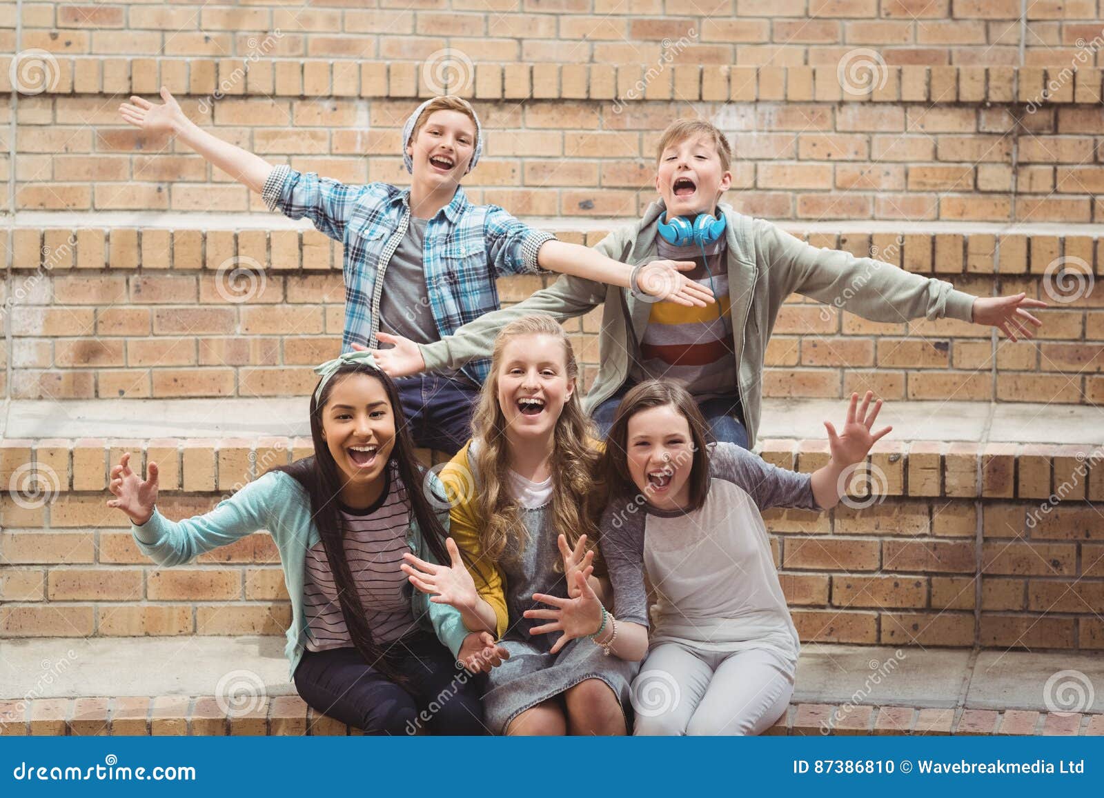 Portrait of Smiling School Students Sitting on Staircase Having Fun in ...
