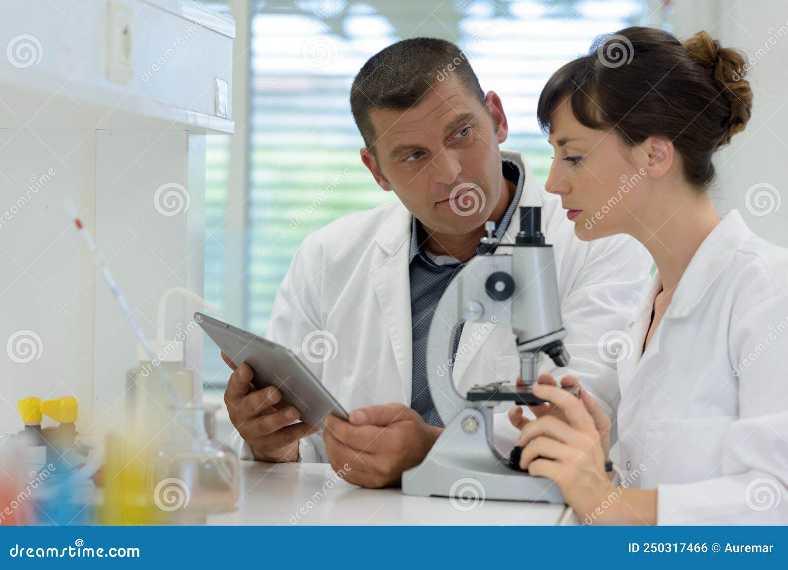 Portrait Smiling Scientists Writing in Notepad in Lab Stock Photo ...
