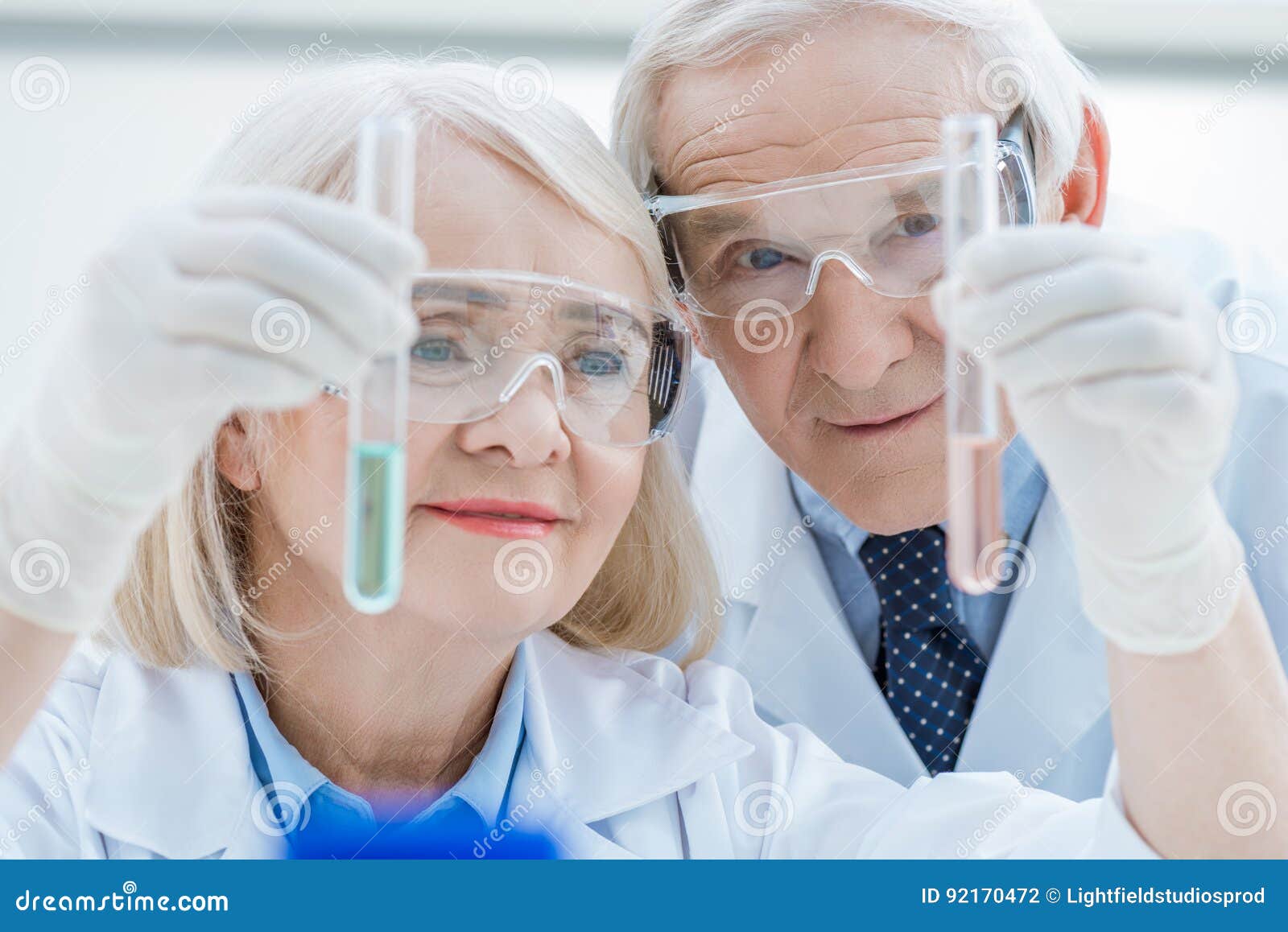 Portrait of Smiling Senior Couple of Scientists Looking at Test Tubes ...