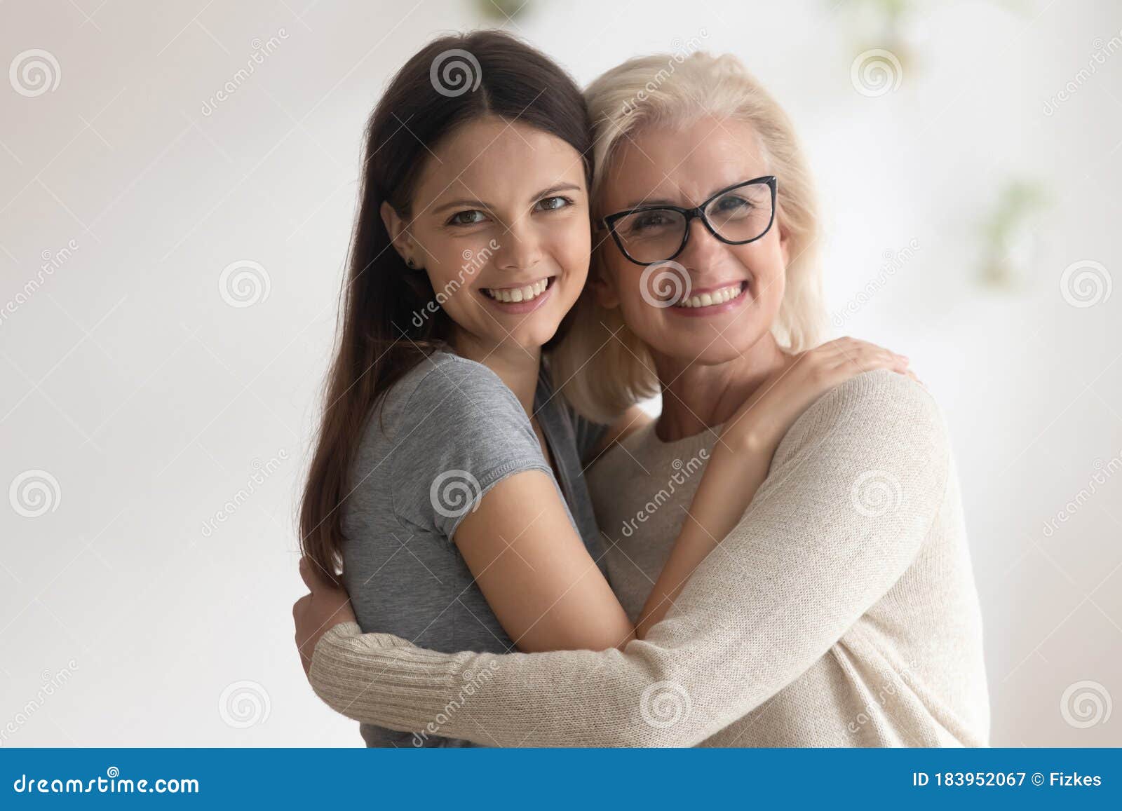 Portrait Of Happy Senior Mother And Adult Daughter Embracing Stock