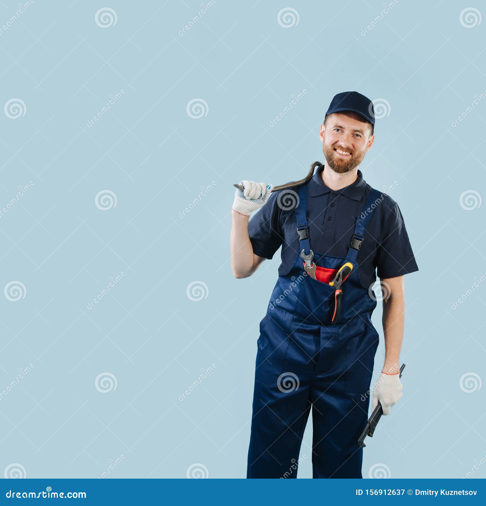 Portrait of a Smiling Service Worker Holding Tools, Dressed in Uniform ...