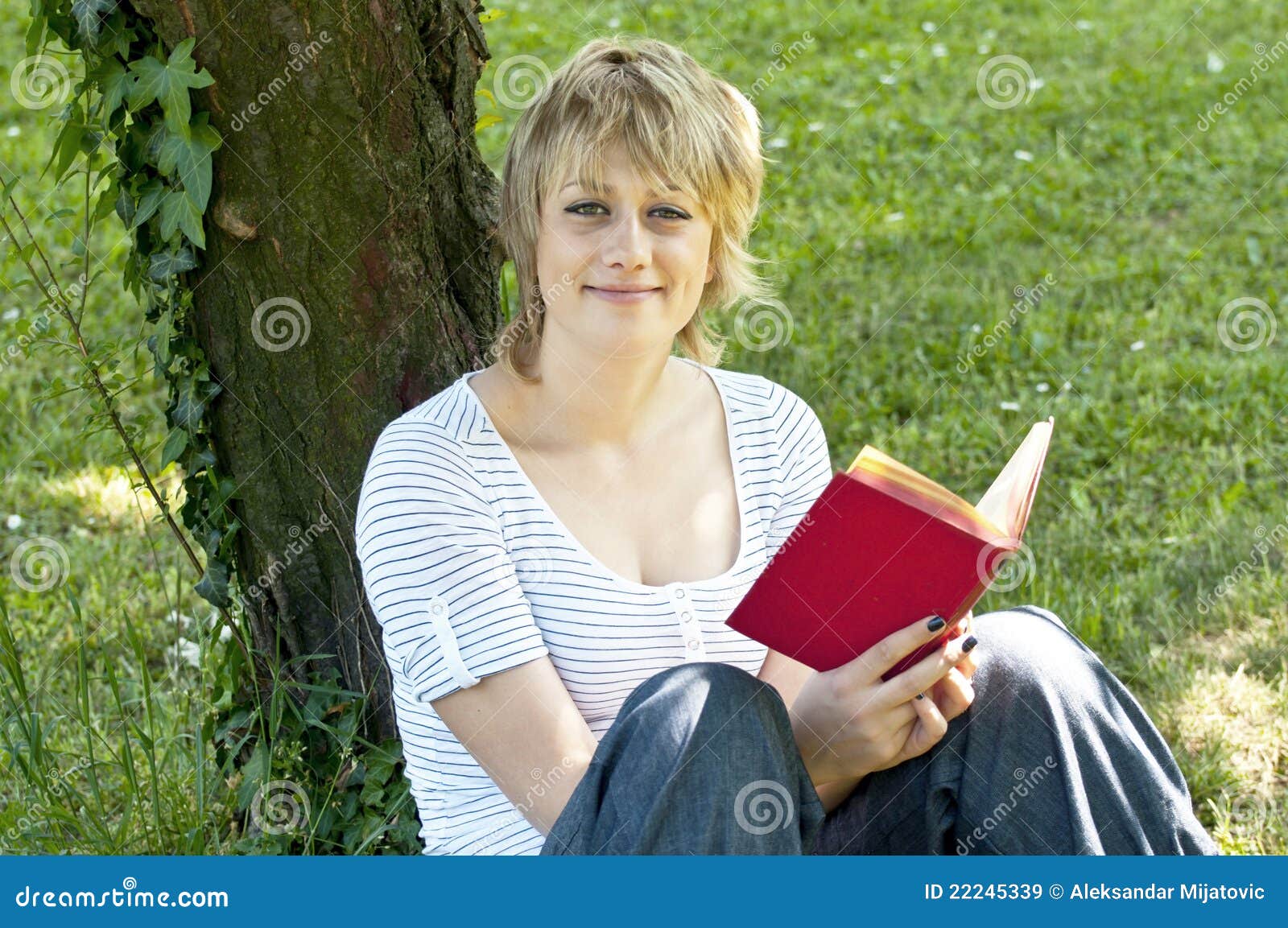 Portrait of Smiling Student Reading Book Stock Image - Image of ...