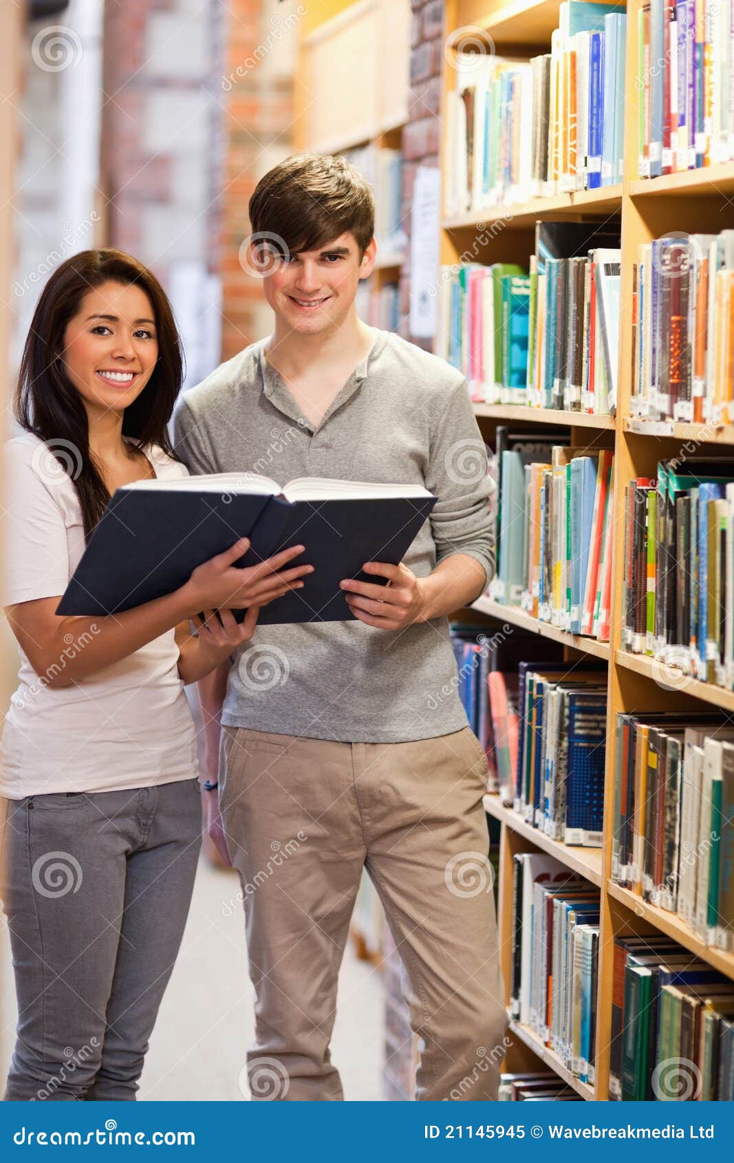 Portrait of Smiling Students Holding a Book Stock Image - Image of race ...