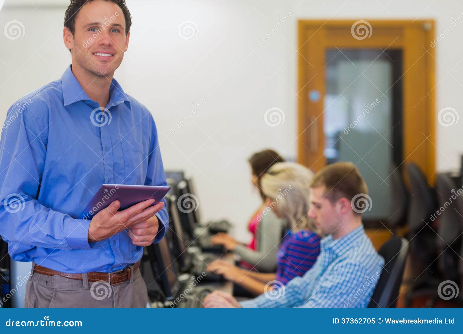 Teacher with Students Using Computers in Computer Room Stock Image ...