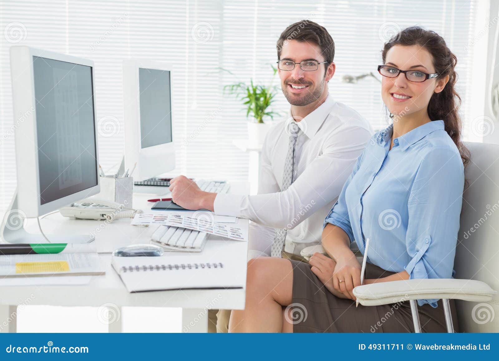 Portrait of Smiling Team Sitting at Desk Stock Image - Image of ...