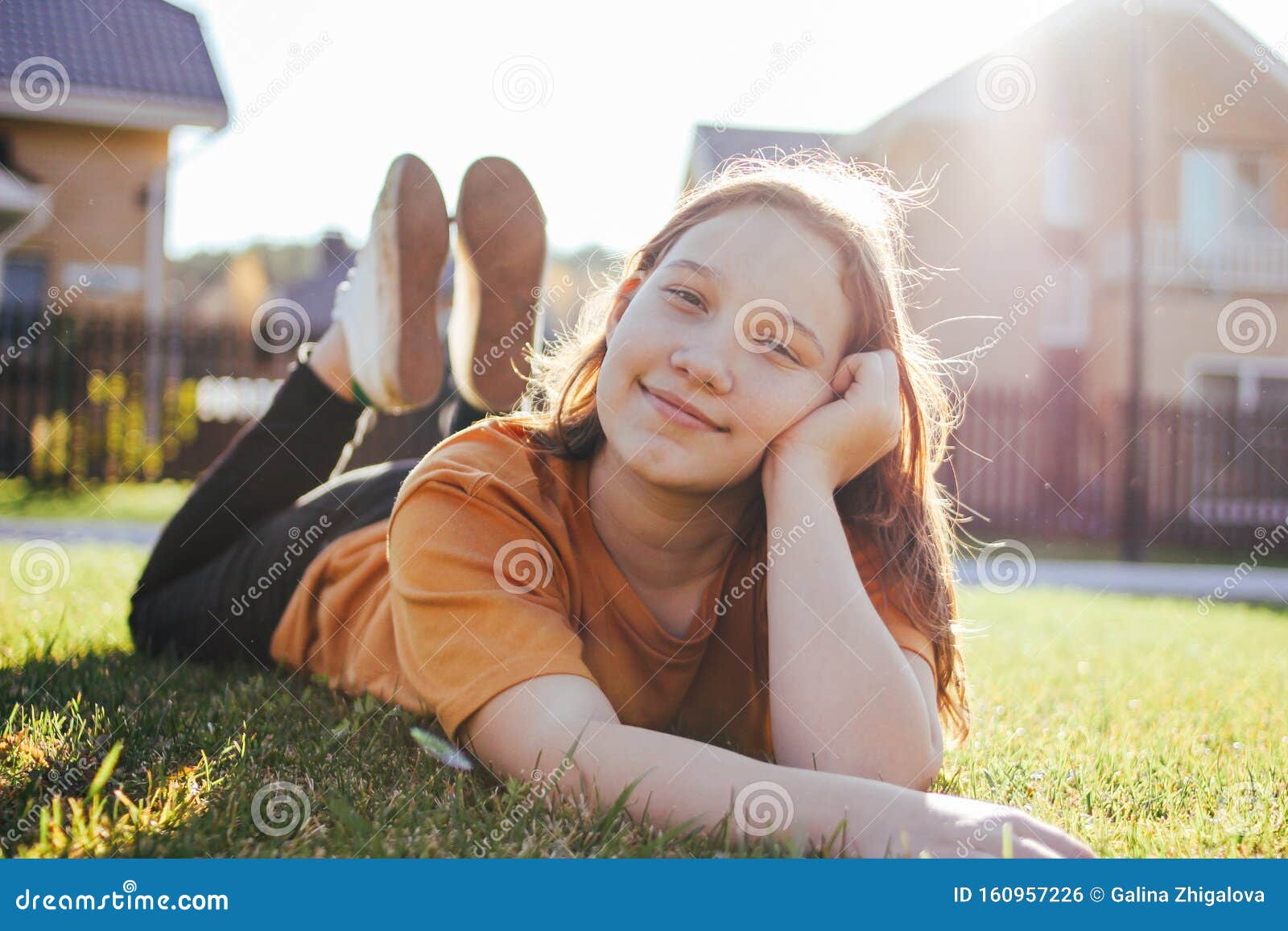 Portrait of Smiling Teen Girl Lying on Sunny Green Grass of Cottage ... Portrait of Smiling Teen Girl Lying on Sunny Green Grass of Cottage ...