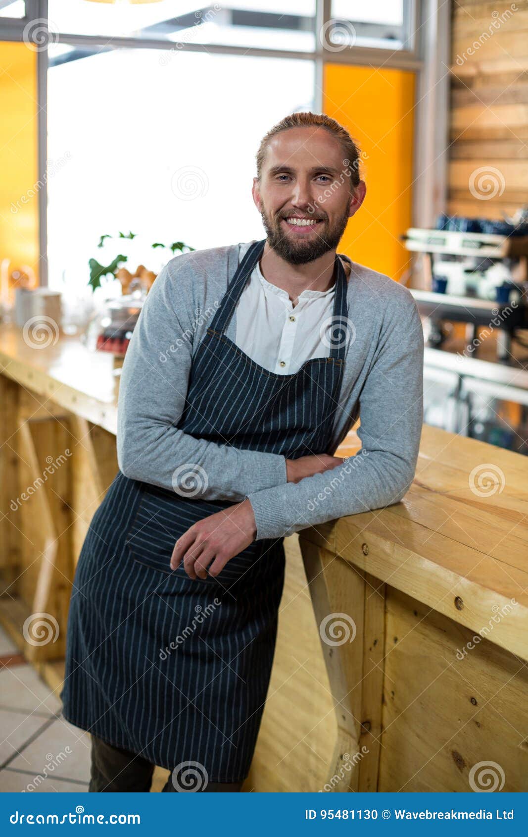 Portrait of Smiling Waiter Leaning at Counter Stock Photo - Image of ...