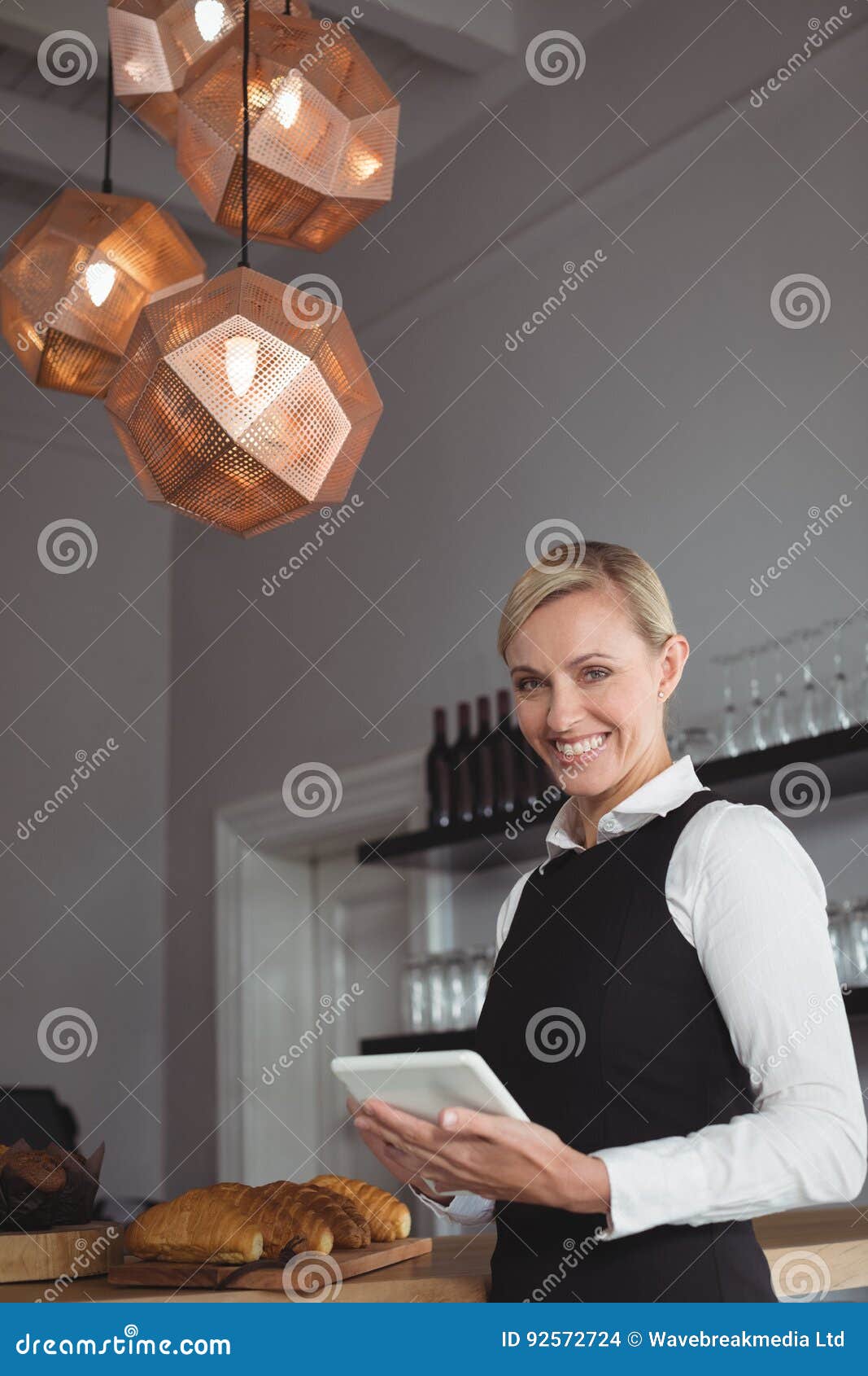 Portrait of Smiling Waitress Holding Digital Tablet at Counter Stock ...