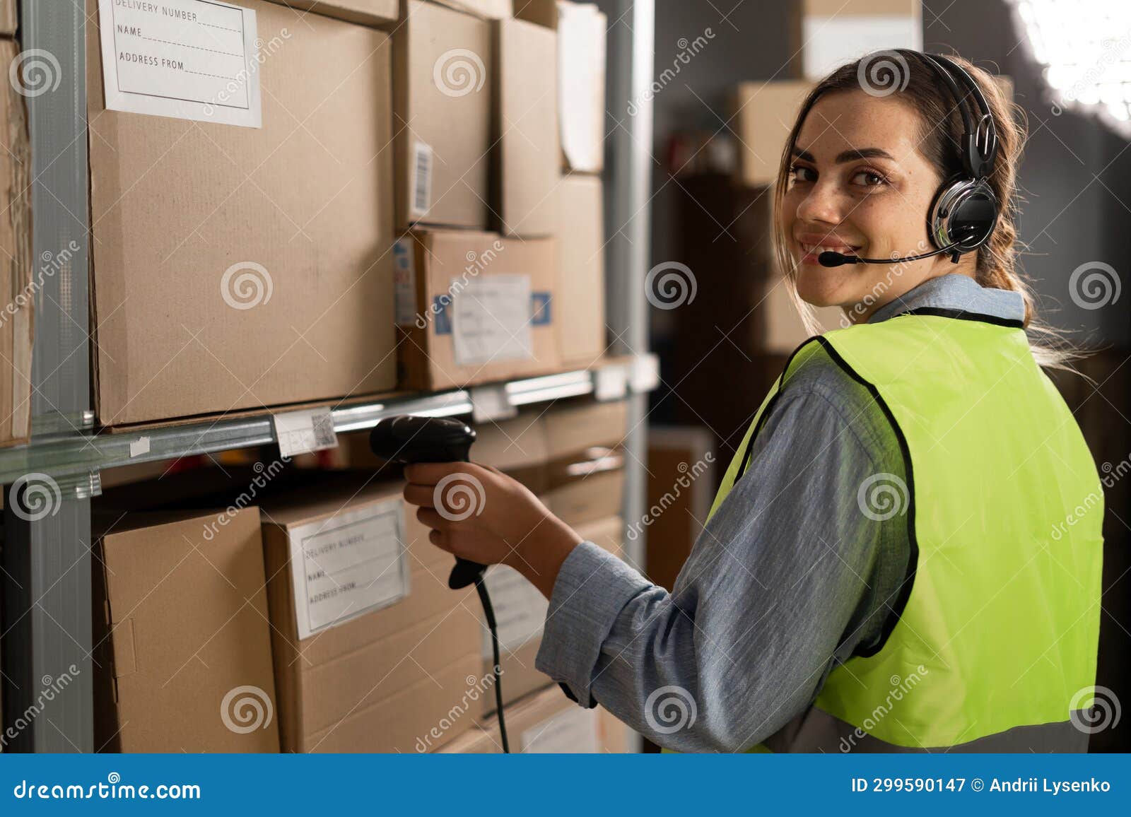 Portrait of a Smiling Warehouse Staff Using a Headset while Working in ...
