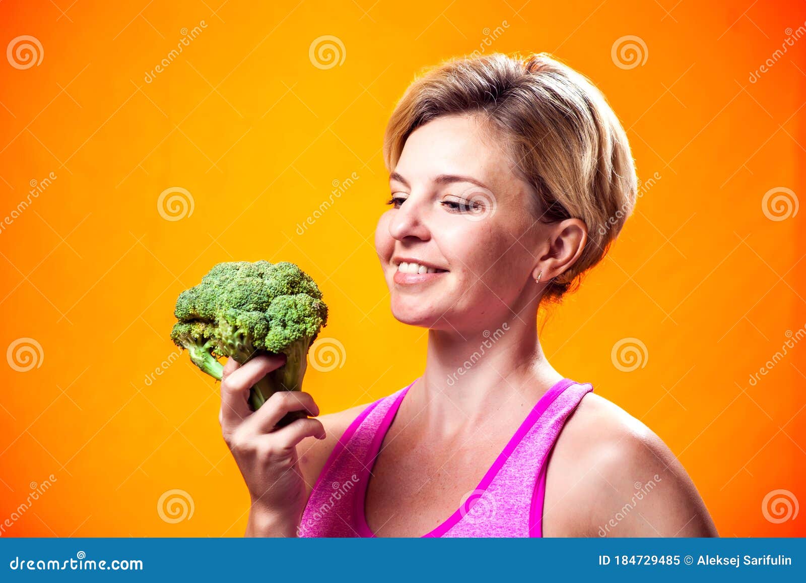 A Portrait Of Smiling Woman Holding Broccoli People Healthcare And
