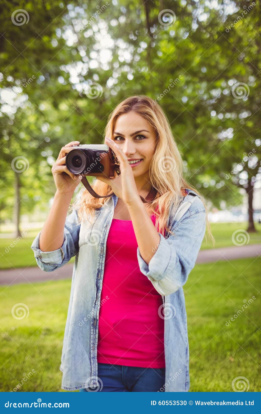 Portrait of Smiling Woman Holding Camera in Park Stock Photo - Image of ...