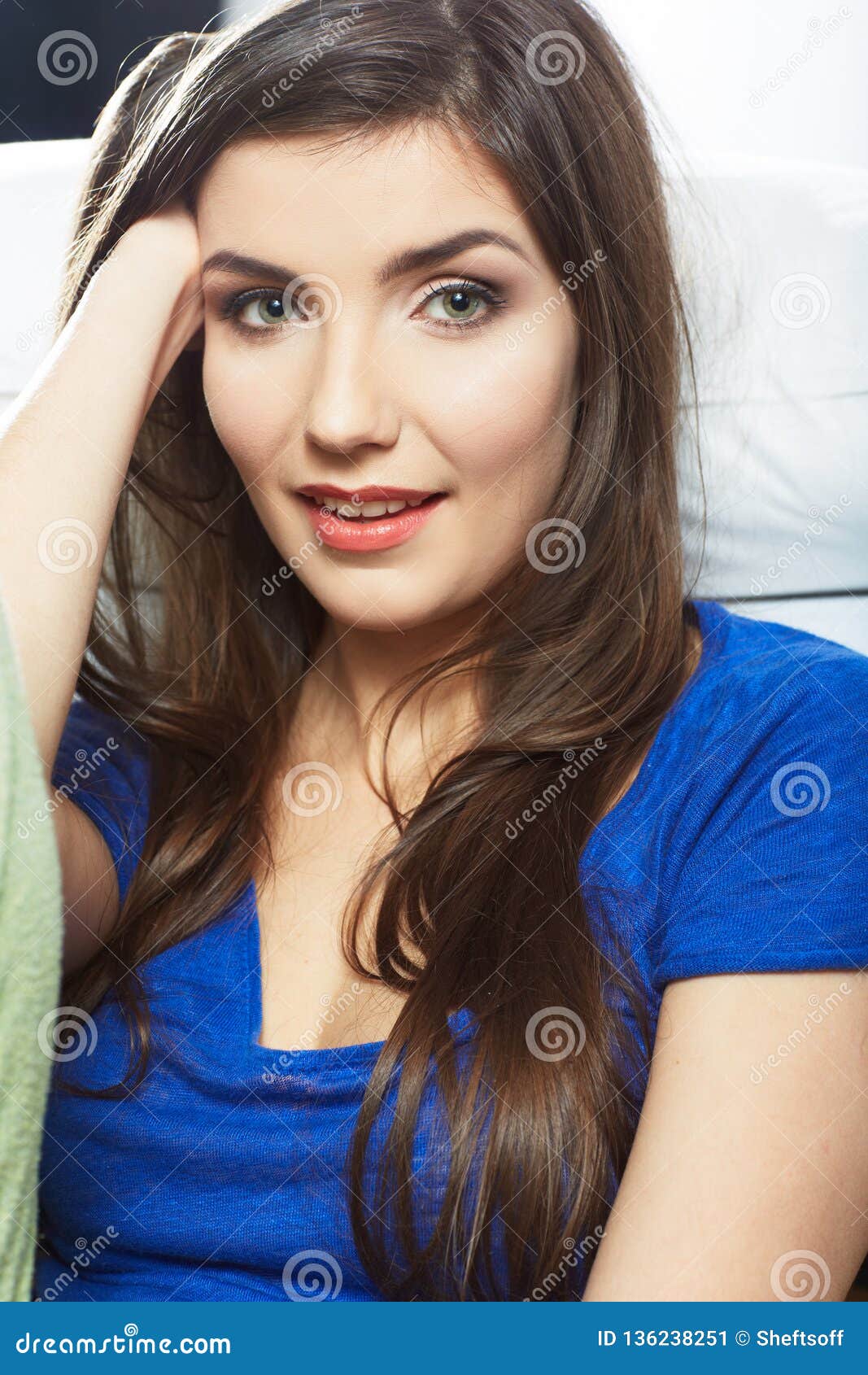 Portrait Of Smiling Woman With Long Brown Hair Seating On Floor Stock