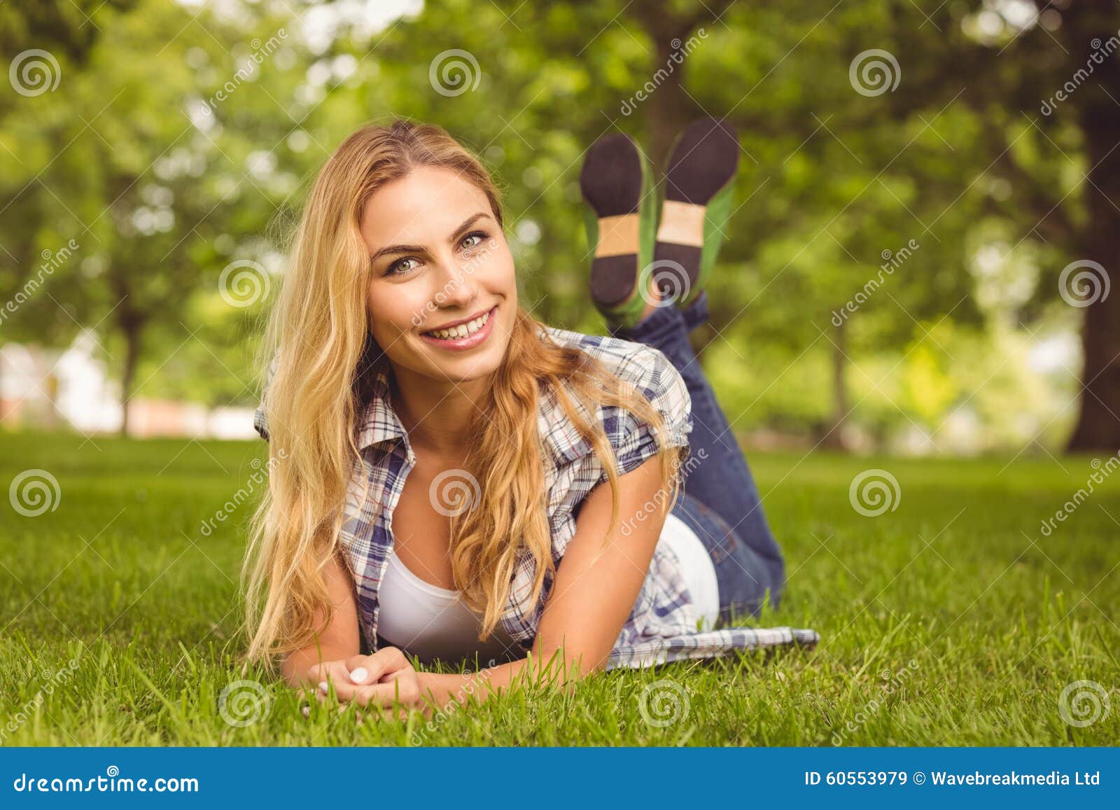 Portrait of Smiling Woman Lying on Front at Park Stock Image - Image of ...