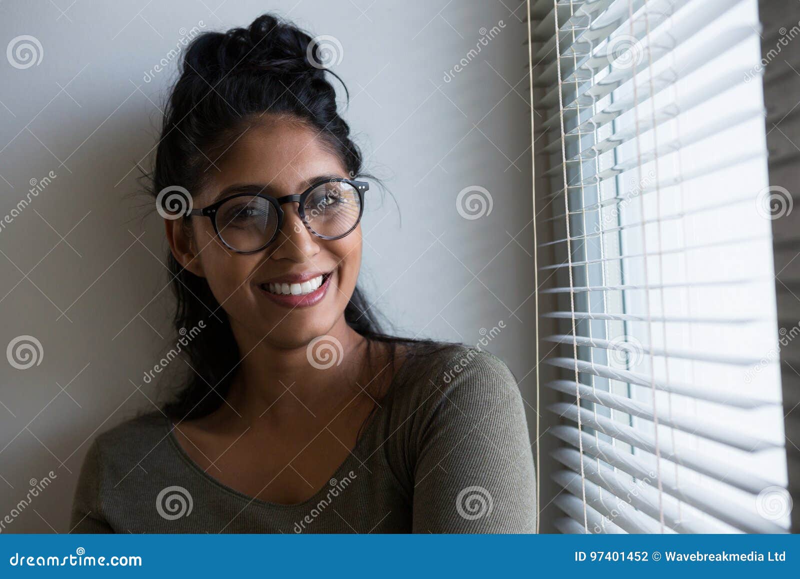 Portrait of Smiling Woman by Window Stock Photo - Image of blinds ...