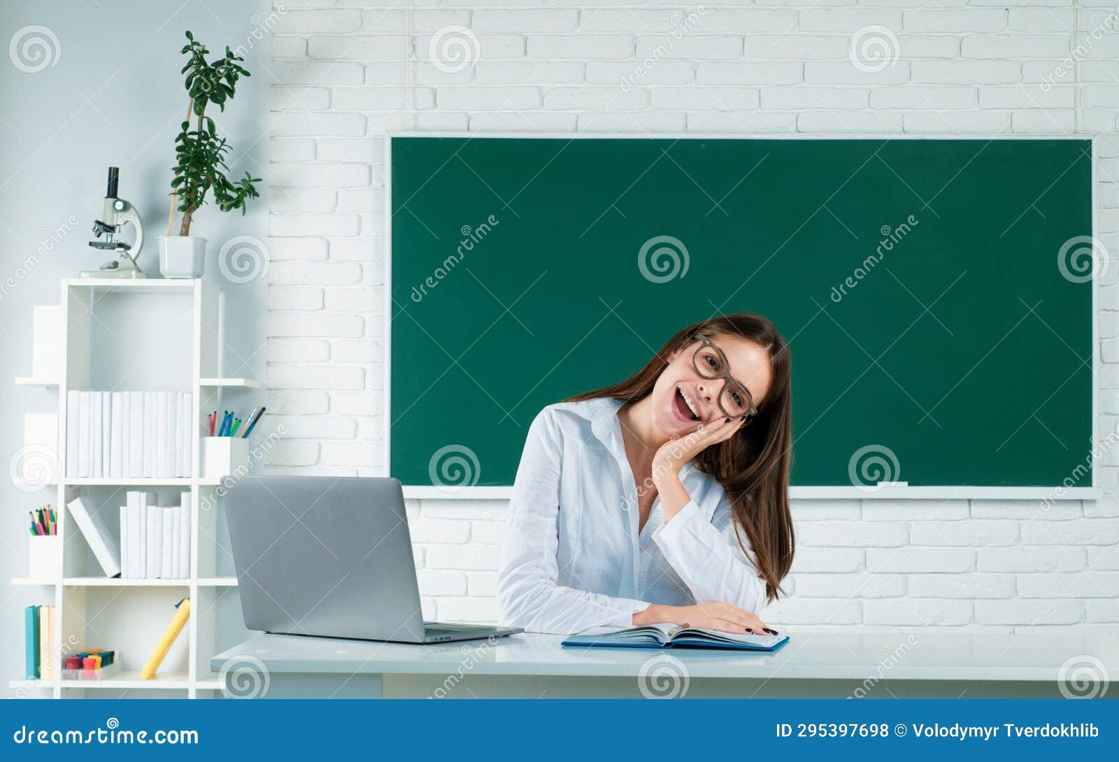 Portrait of Smiling Young College Student Studying with Laptop Computer ...