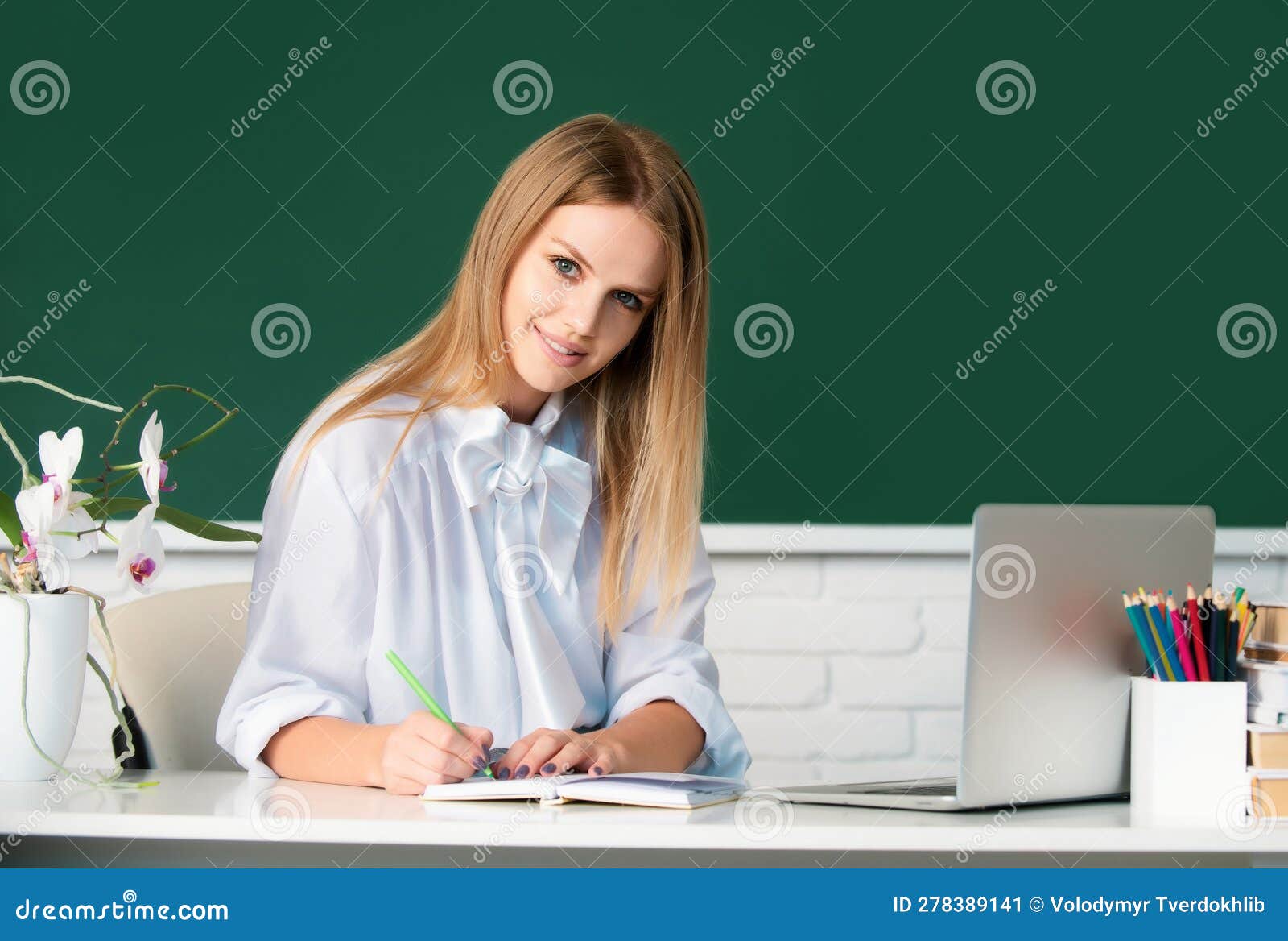 Portrait of Smiling Young College Student Writing, Studying in ...