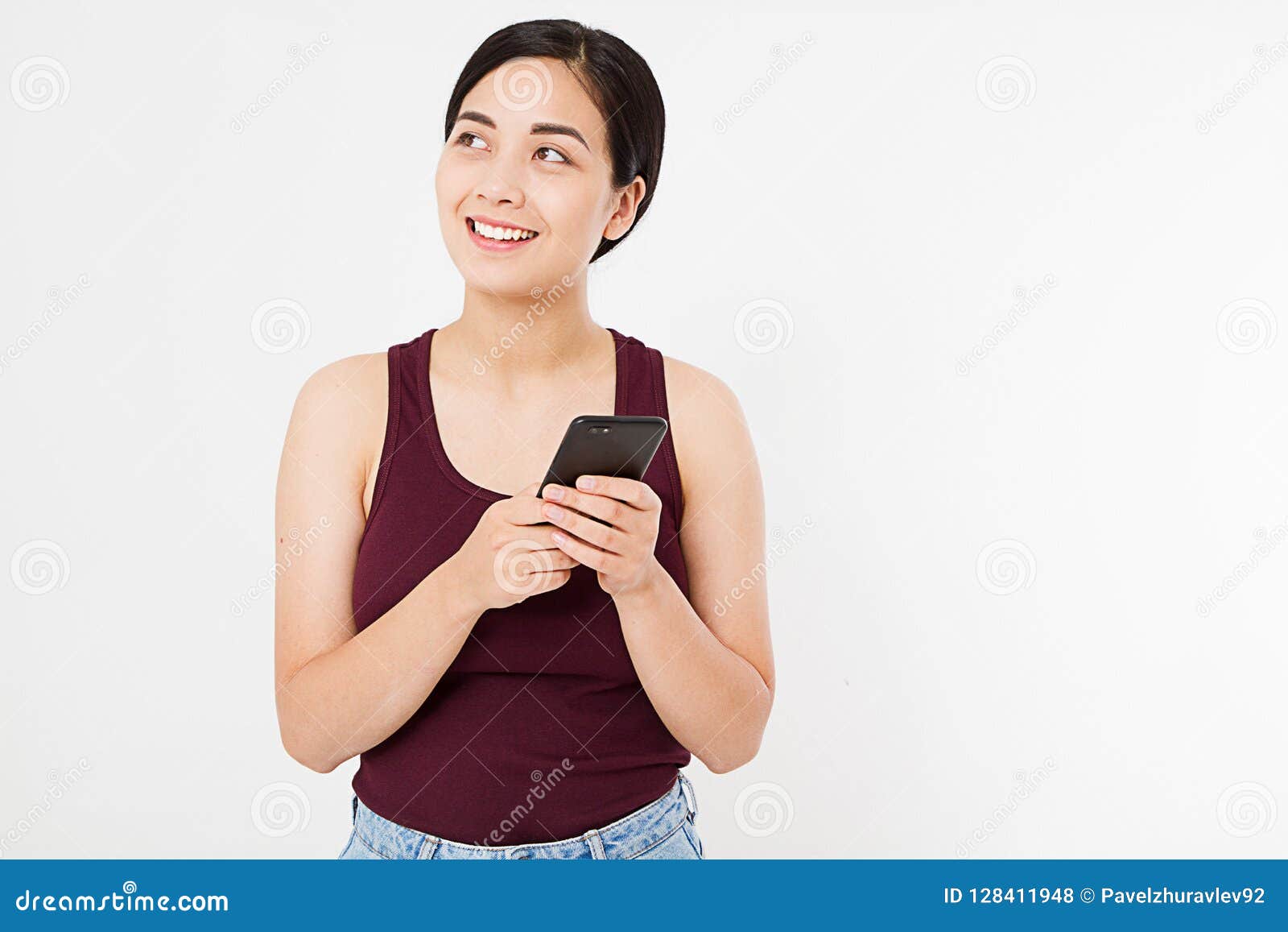 Portrait Of A Smiling Young Korean Asian Woman Holding Mobile Phone