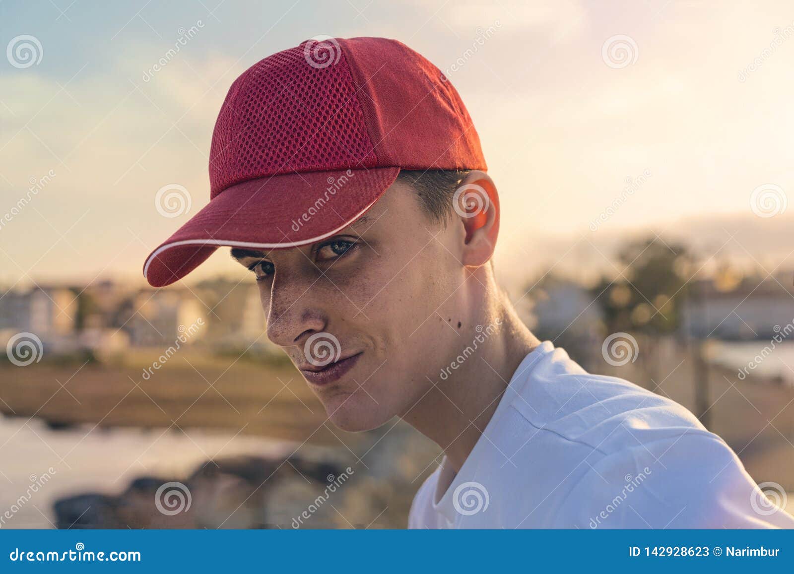 Smiling Young Man with Red Baseball Cap Stock Image - Image of smiling ...
