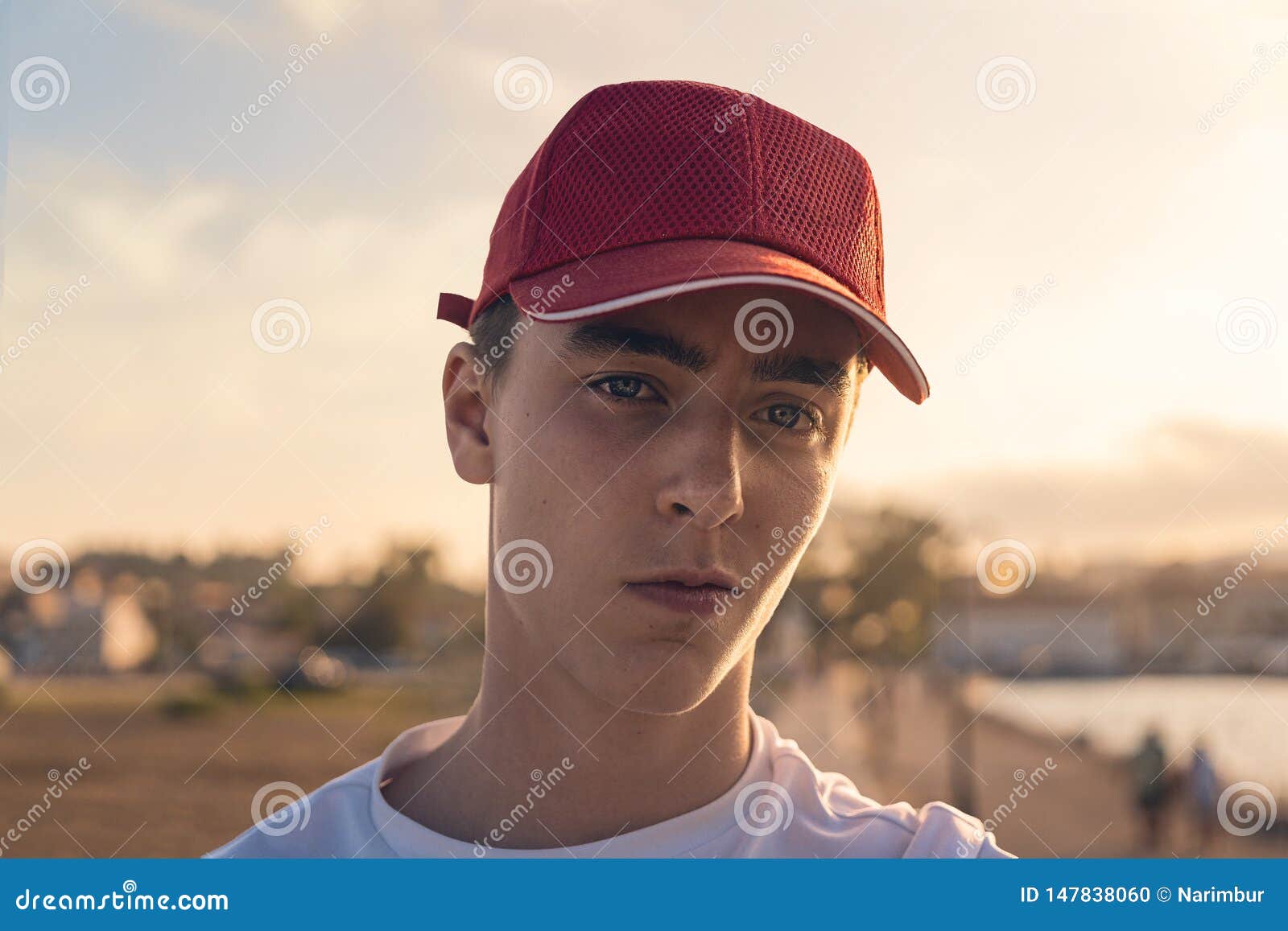Smiling Young Man with Red Baseball Cap Stock Photo - Image of harbor ...