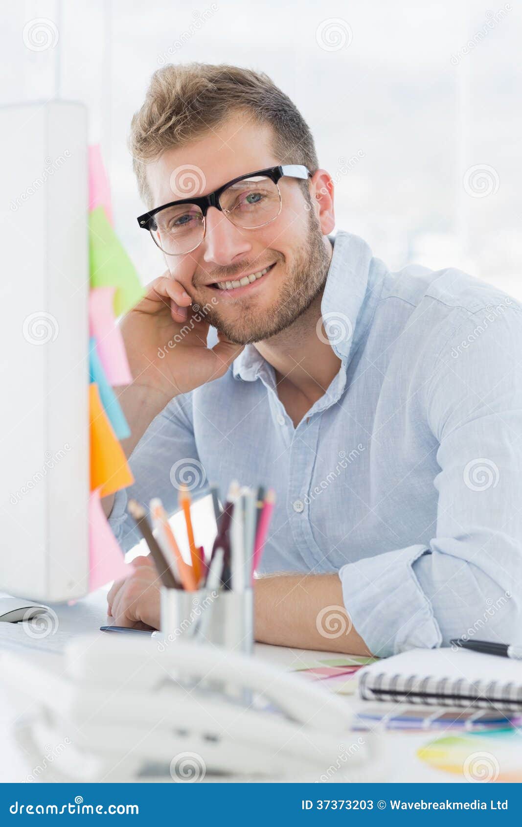 Portrait of a Smiling Young Man Using Computer Stock Image - Image of ...