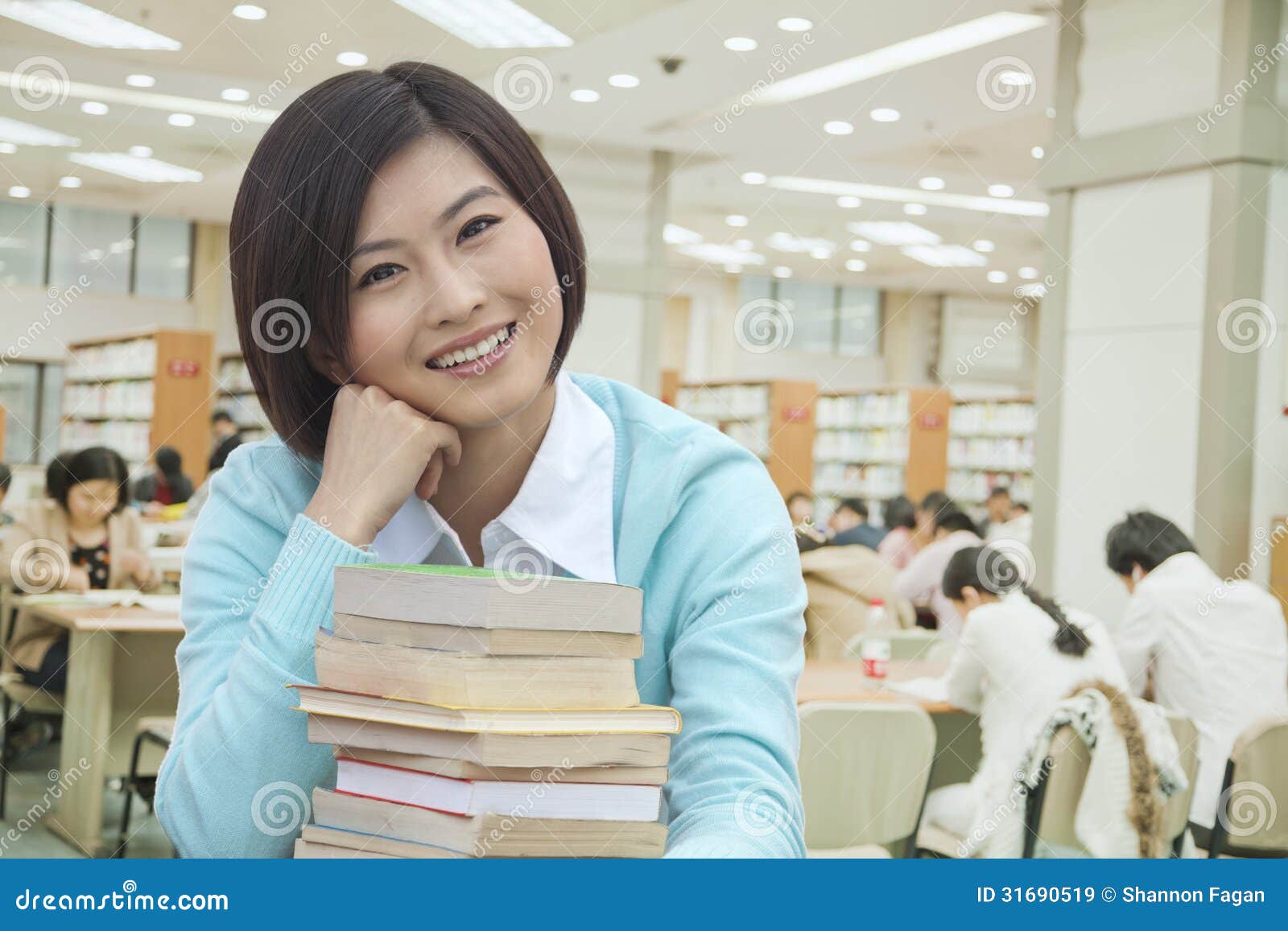 Portrait of Smiling Young Woman in Library Stock Image - Image of ...