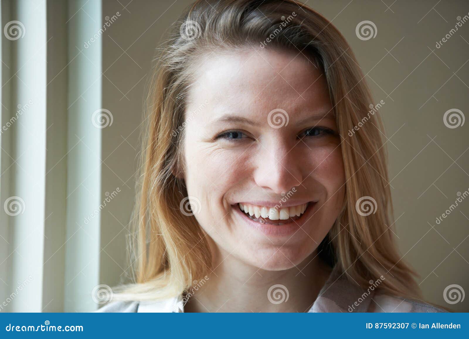 Portrait of Smiling Young Woman Standing by Window Stock Image - Image ...