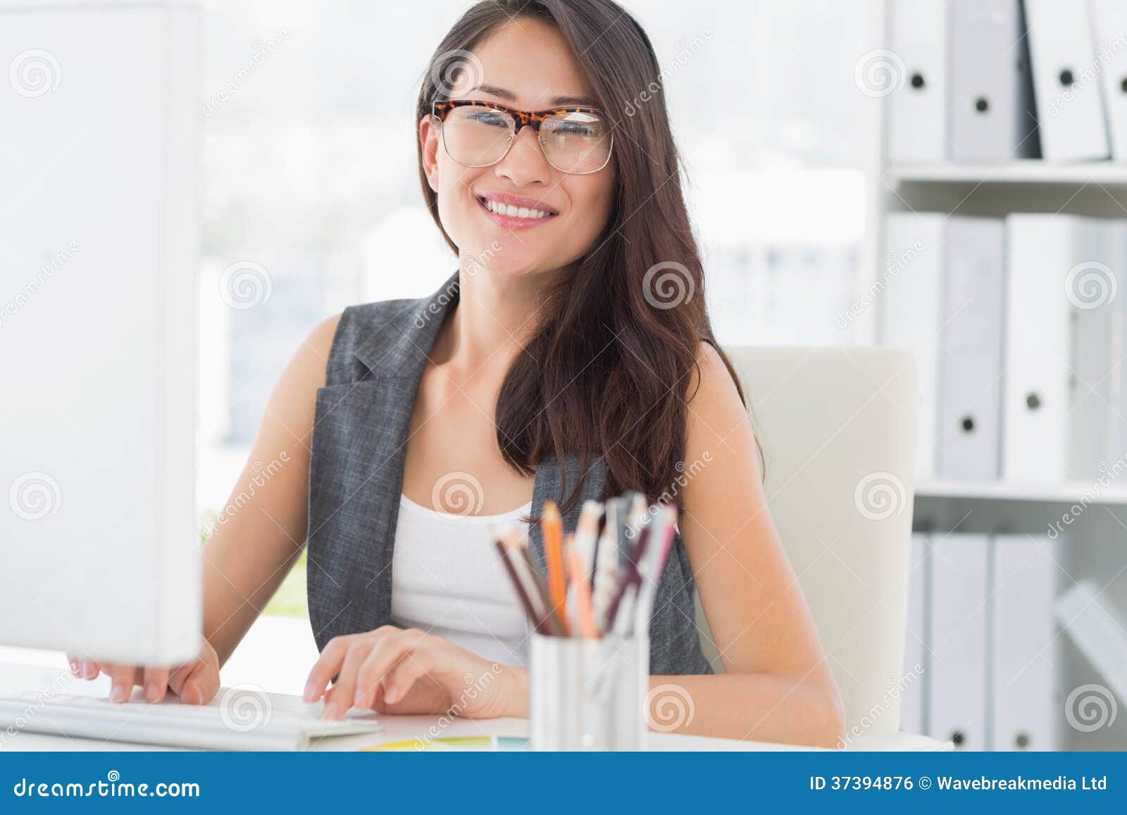 Portrait of a Smiling Young Woman Using Computer Stock Photo - Image of ...