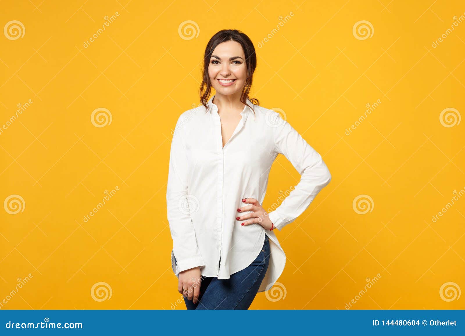 Portrait Of Smiling Young Woman In White Shirt Jeans Standing And