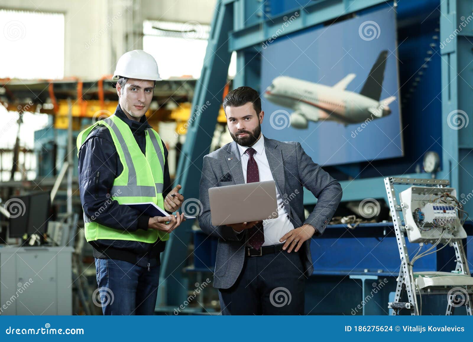 Portrait of a Solid Businessman with Laptop and Factory Engineer ...