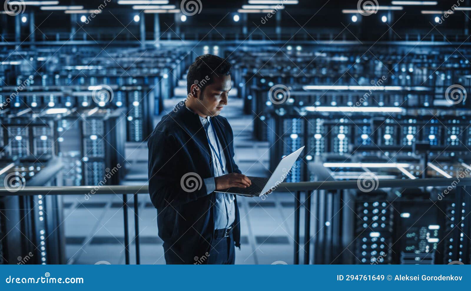 Portrait of it Specialist Uses Laptop in Data Center. Server Farm Cloud ...